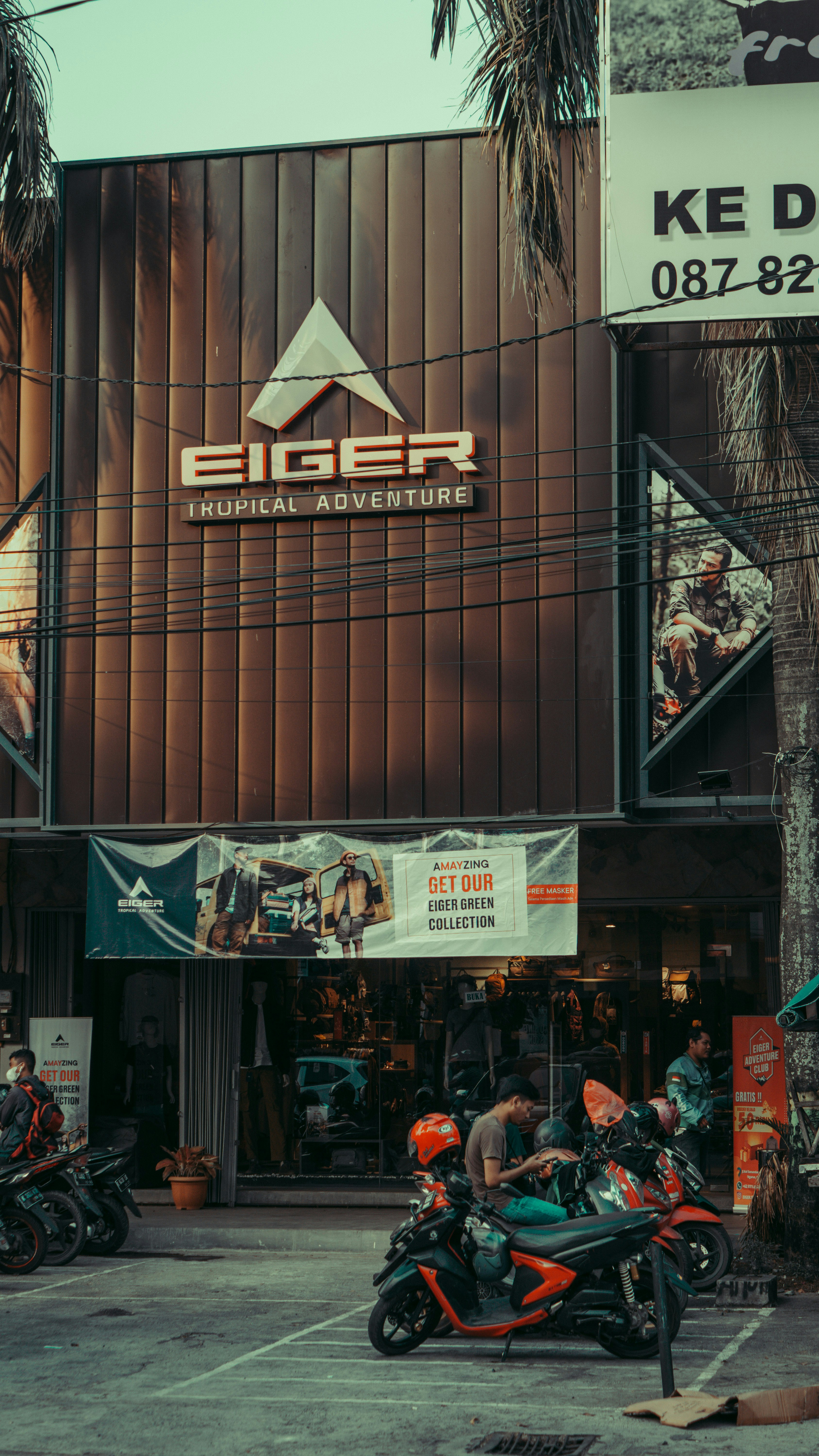 Vibrant street-front: EIGER shop and motorcycles beneath a bold logo