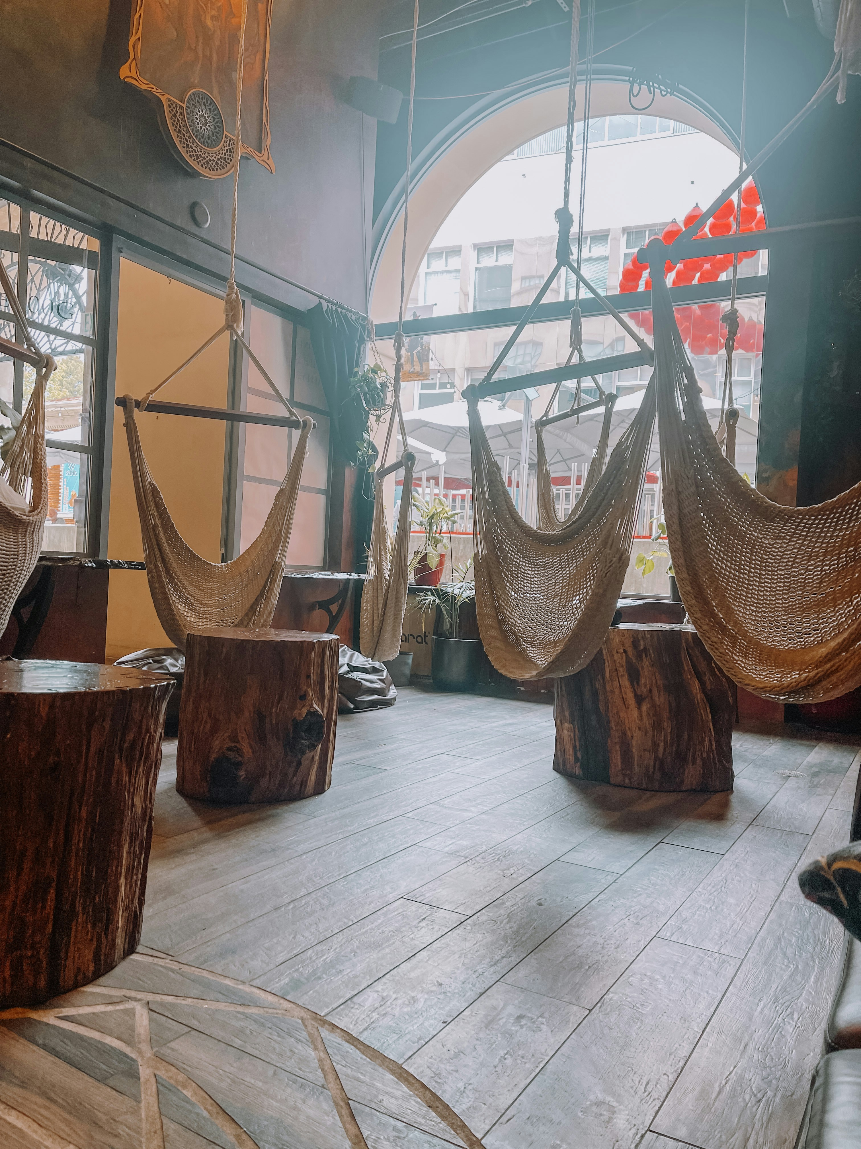 A room with hammocks hanging from the ceiling photo – Free Cafe ambiance Image on Unsplash