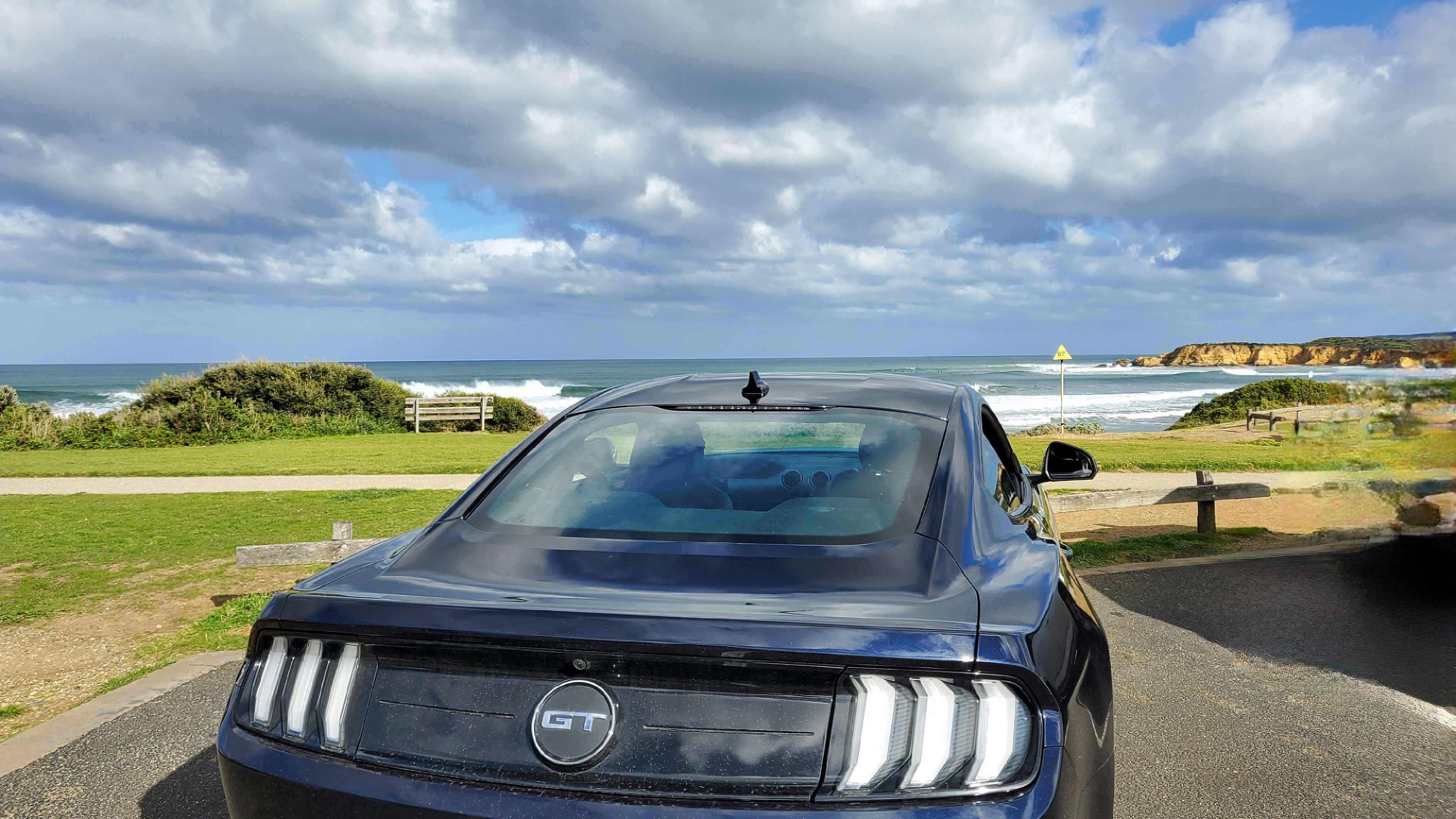 Coastal Portrait: Blue Mustang GT Front-and-Center by the Sea Cliffs
