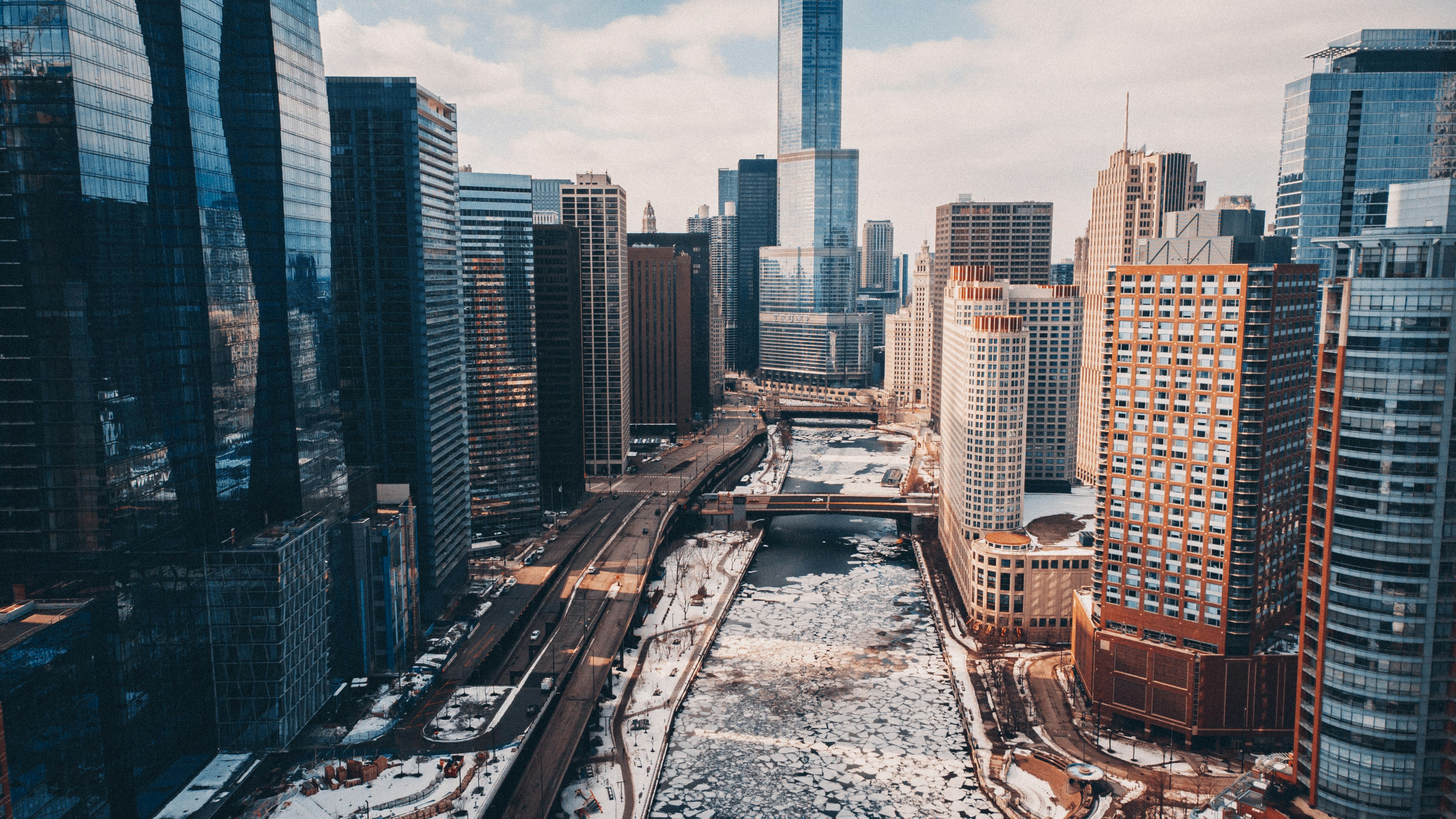 A river running through a city surrounded by tall buildings photo ...