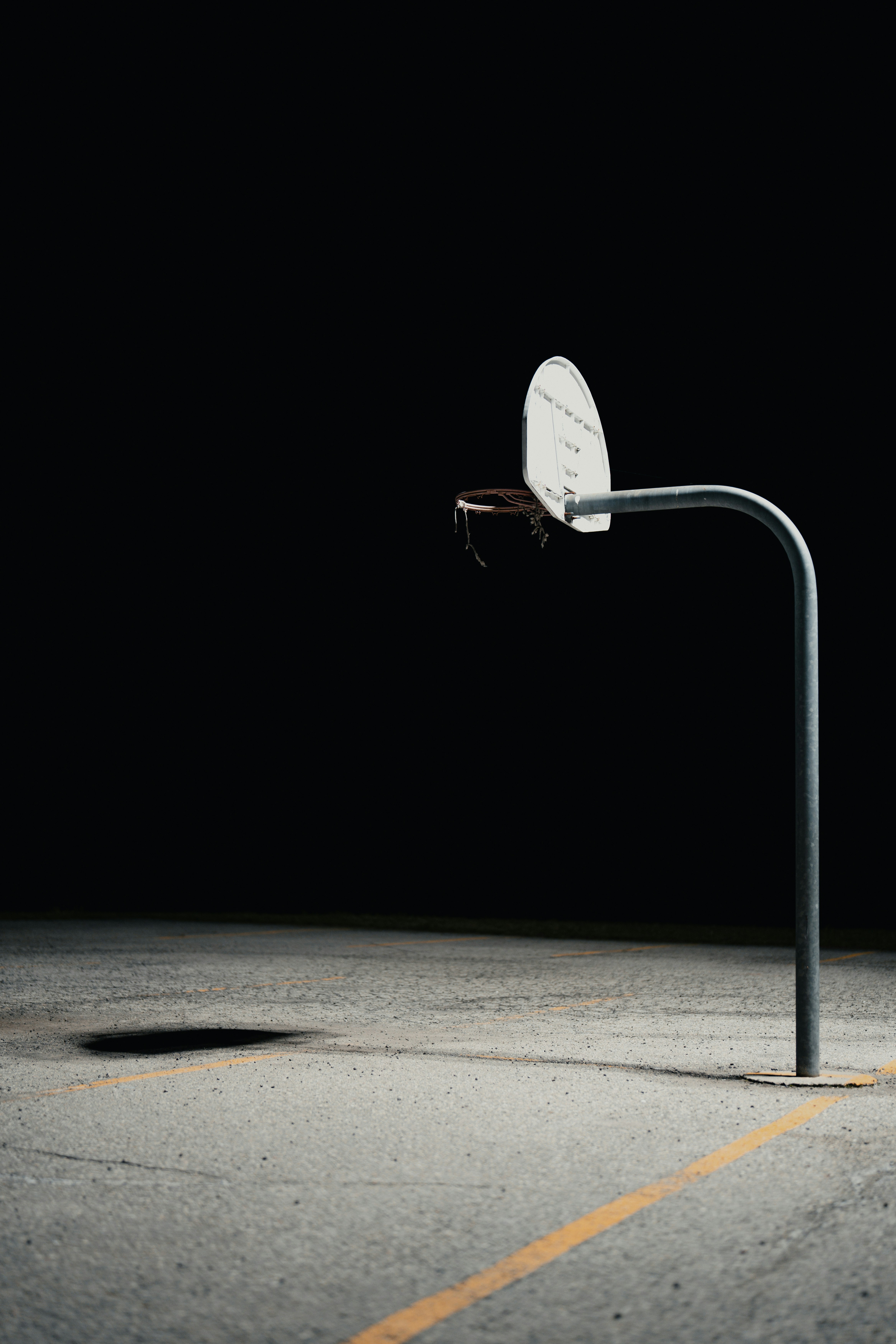Moonlit Hoop Stand: A Silent Goal in an Empty Parking Lot