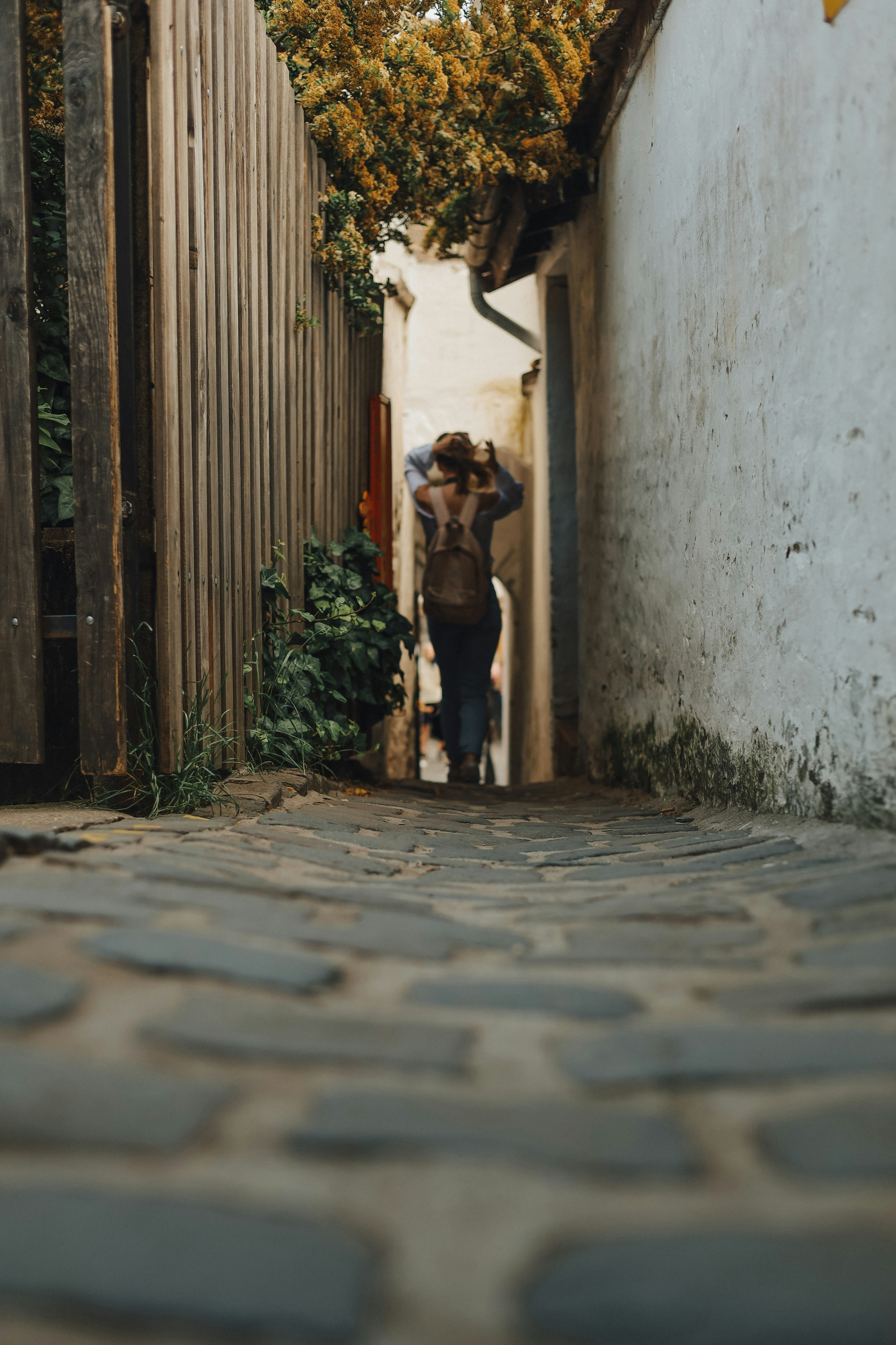 Couple in a Narrow Street: A Quiet Embrace Between Walls