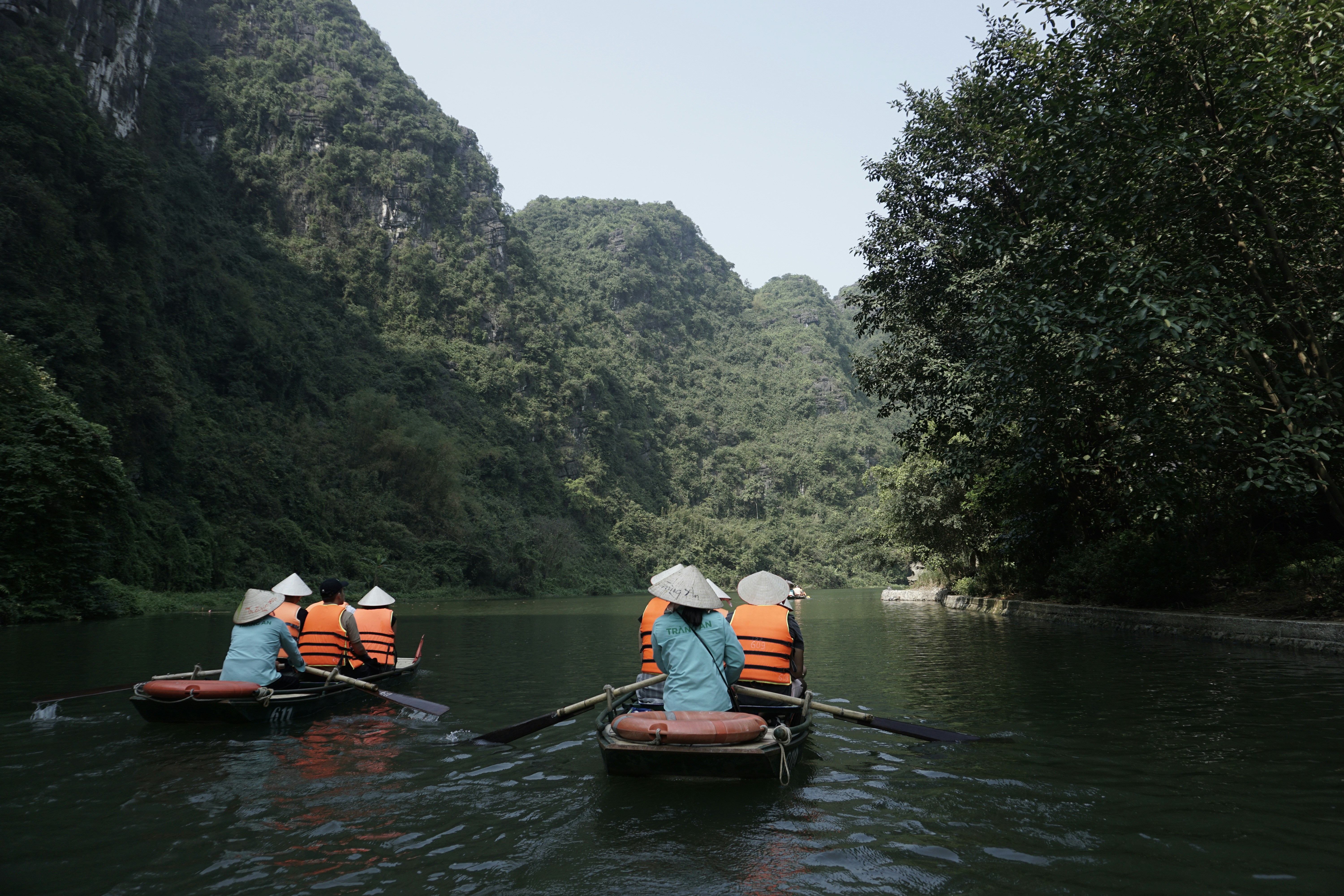 Emerald Gorge Drift: Three Life-Jacketed Paddlers on a Quiet River