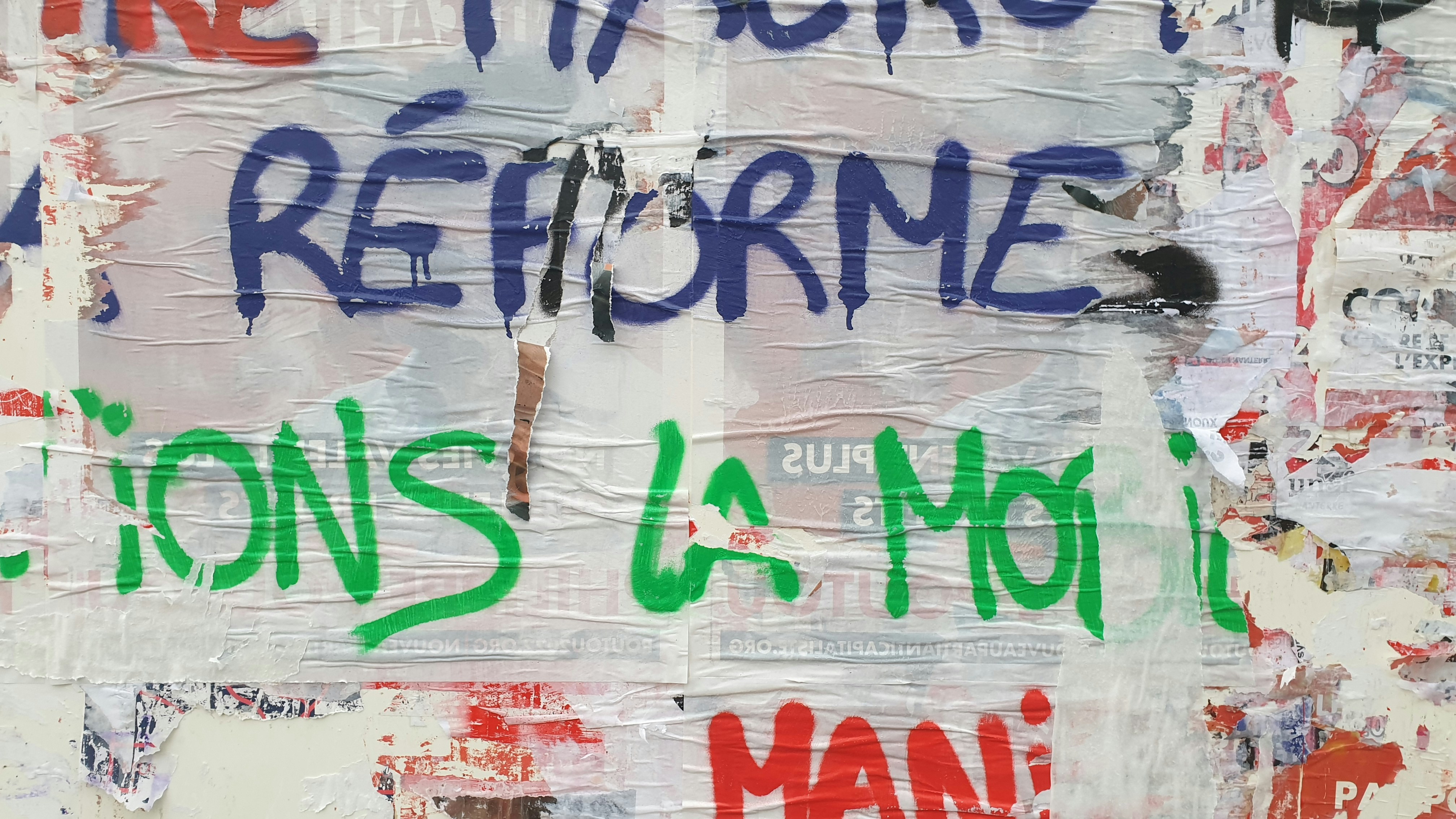 A bunch of signs that are on a wall photo – Free Wall texture Image on ...