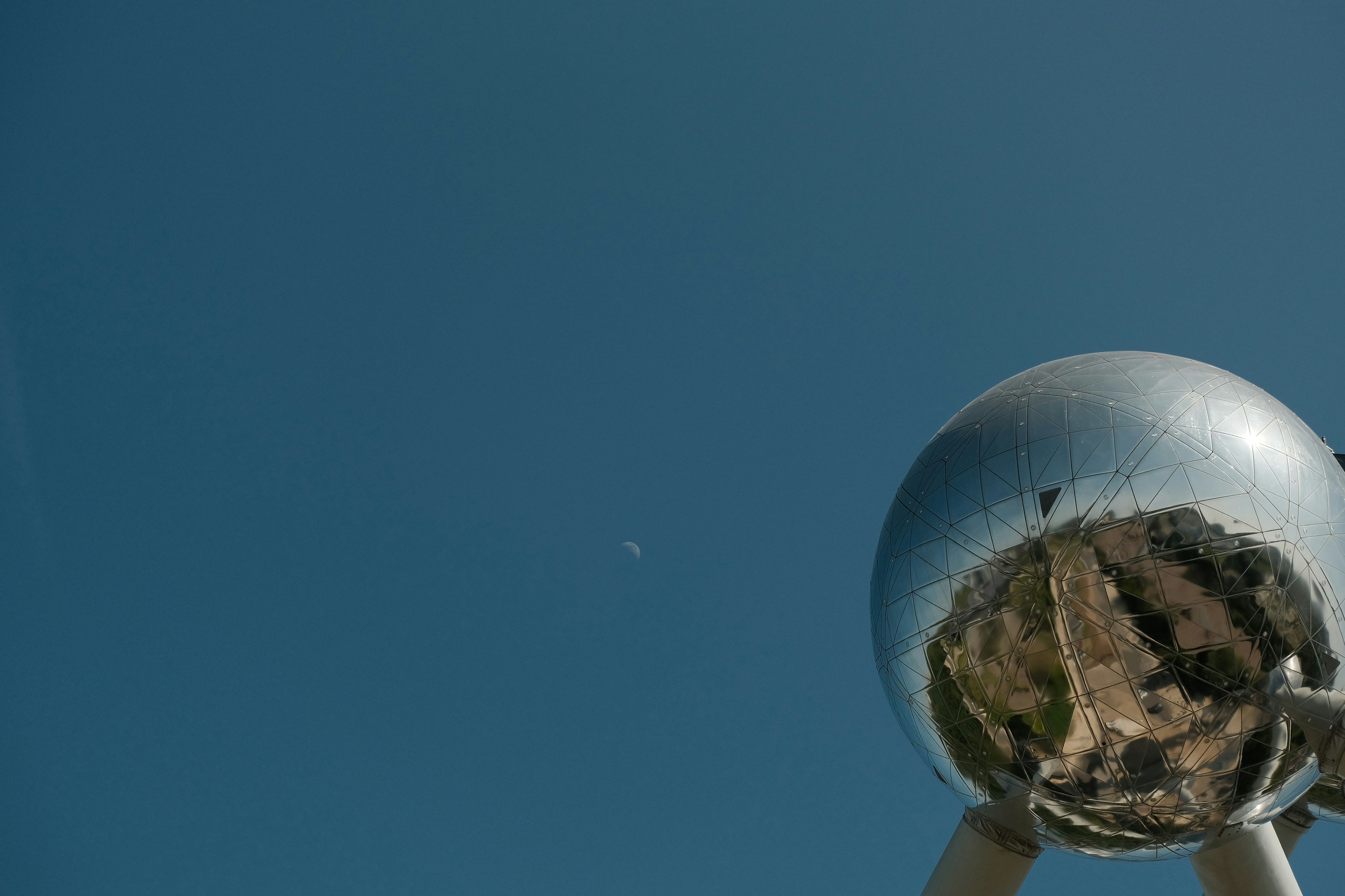 Moonlit Sphere: A Chromium Reflective Dome Against a Clear Sky