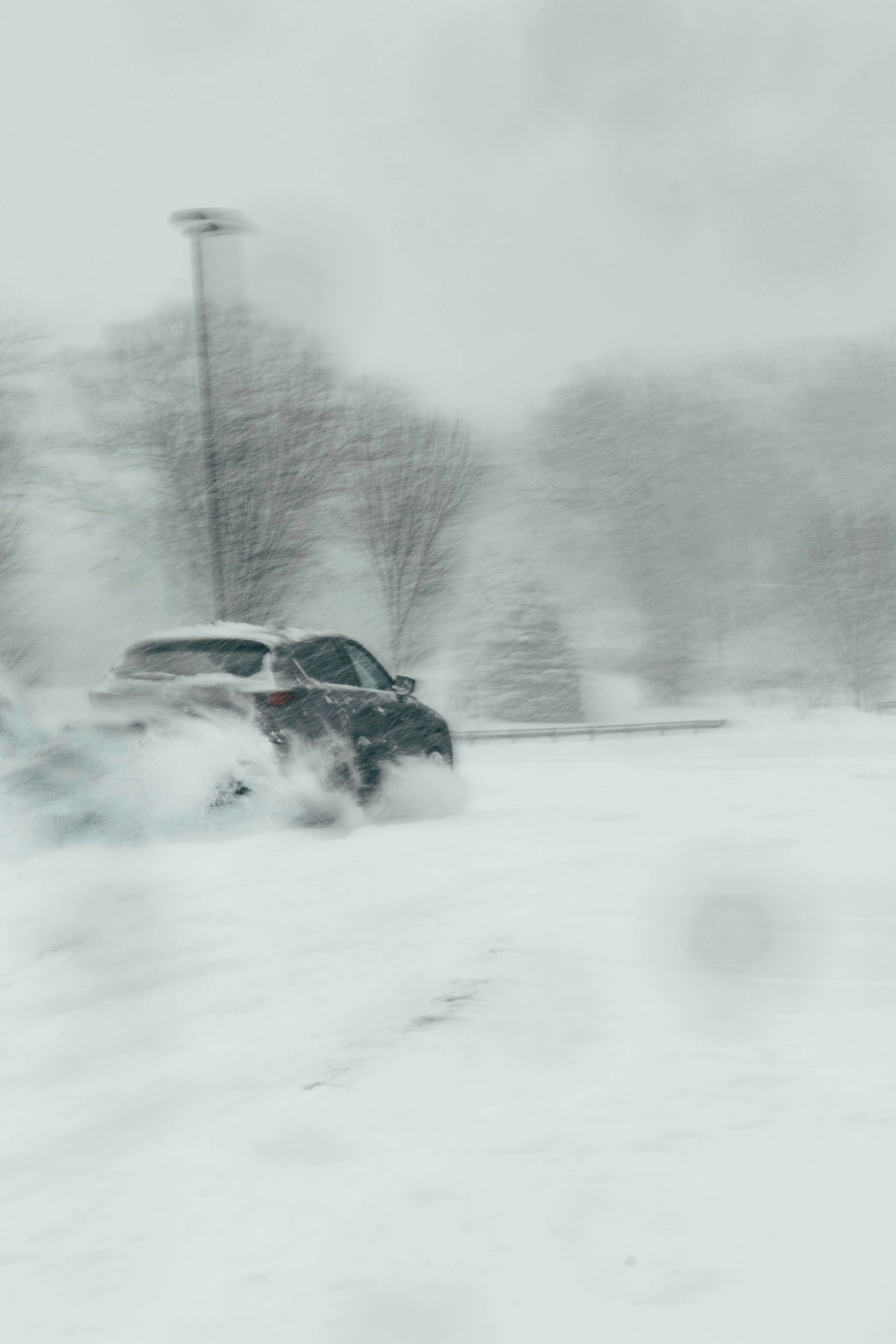 A car driving through a snow covered parking lot photo – Free Purdue ...
