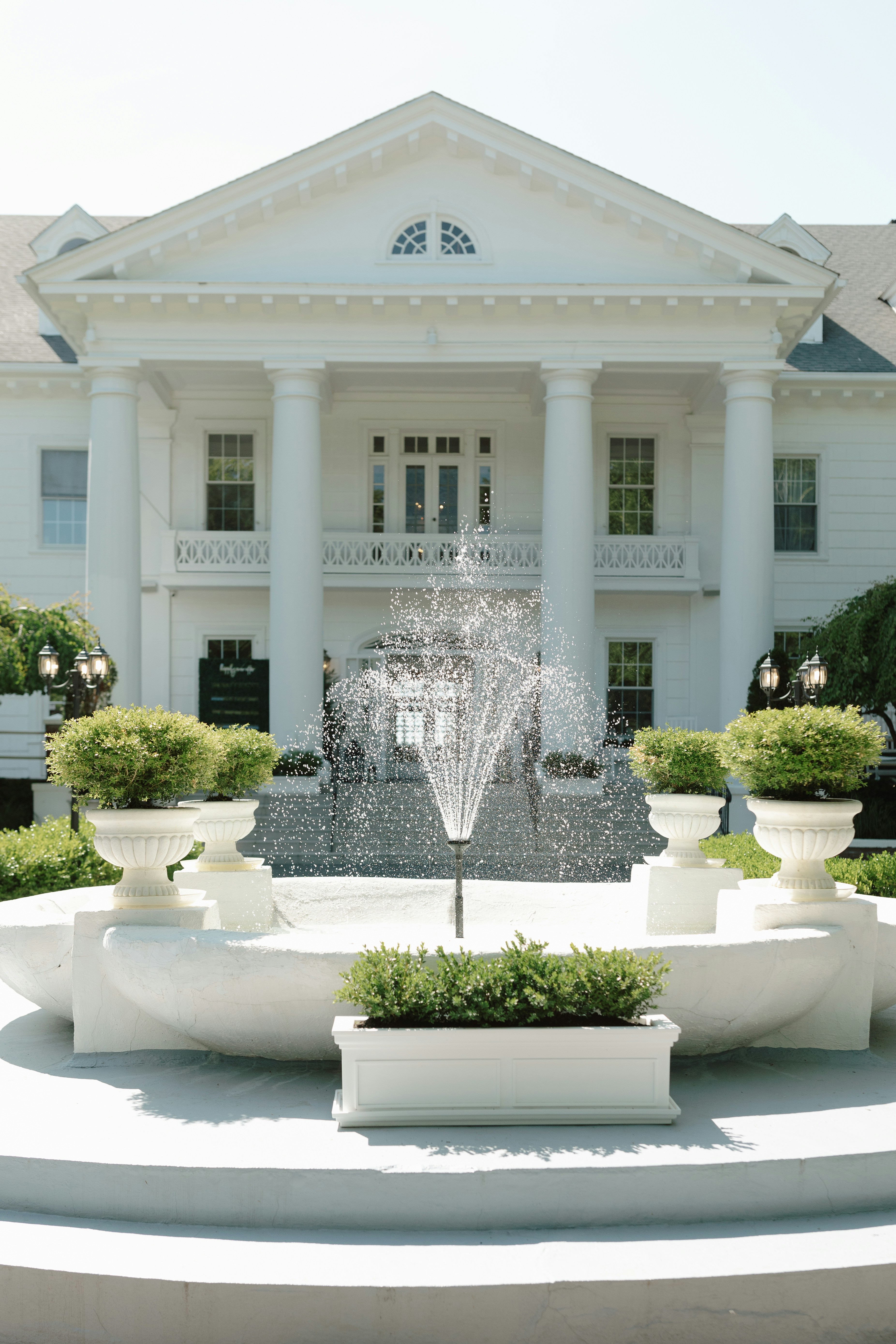 A large white building with a fountain in front of it photo – Free ...