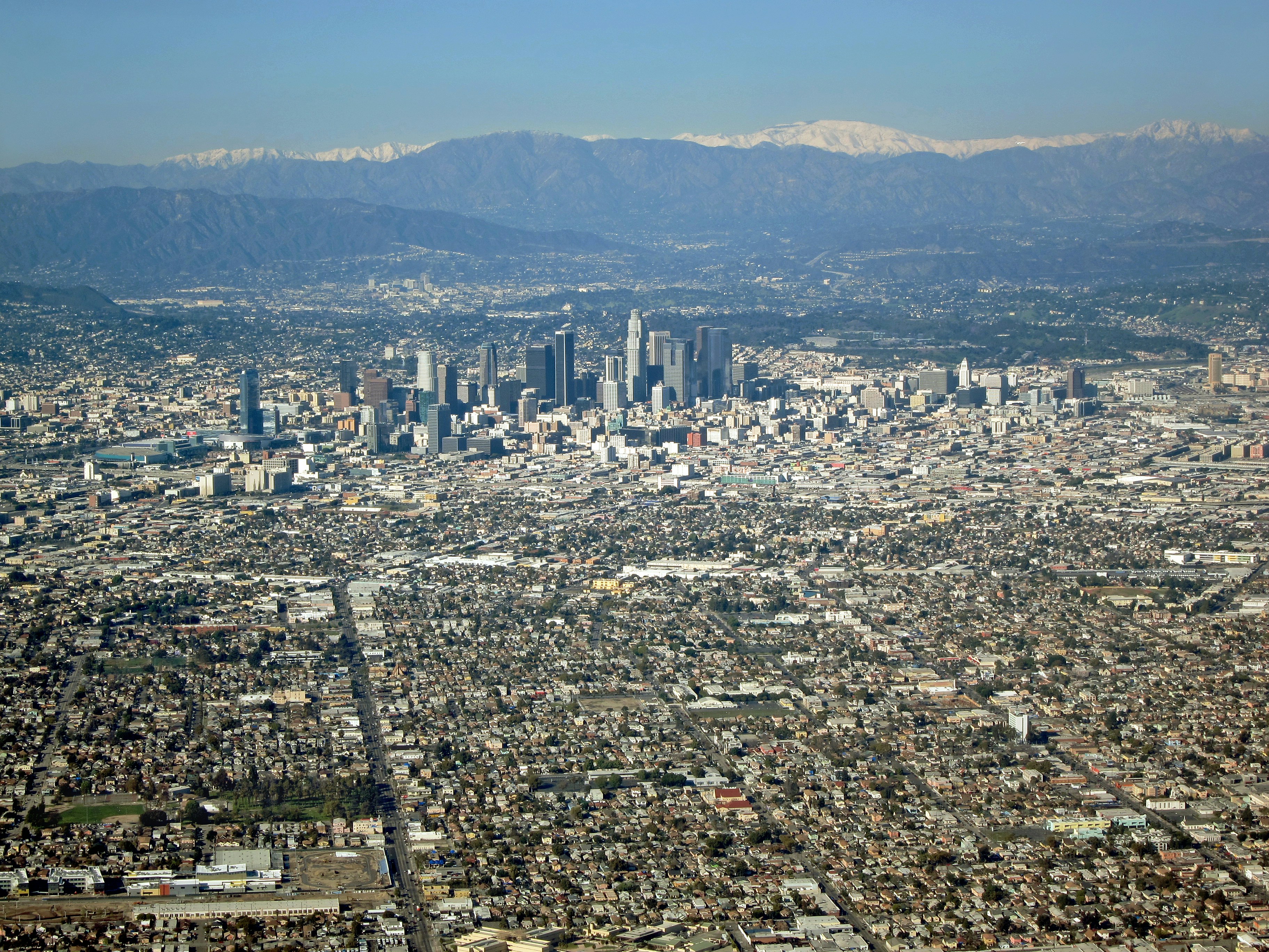 Downtown Los Angeles and surrounding areas with mountains in the background.