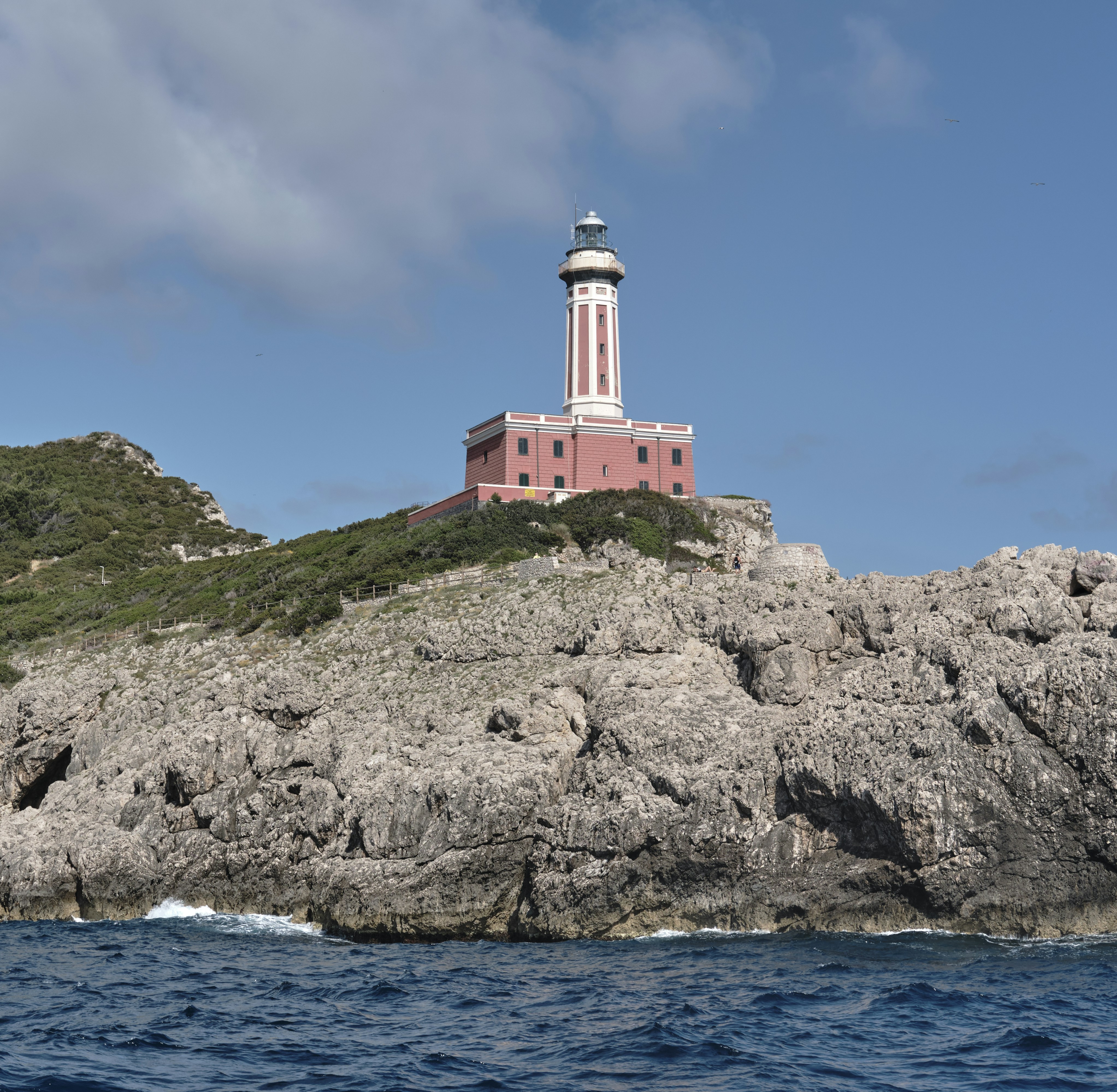 Beacon Over Granite: Lighthouse on a Rugged Coastal Cliff