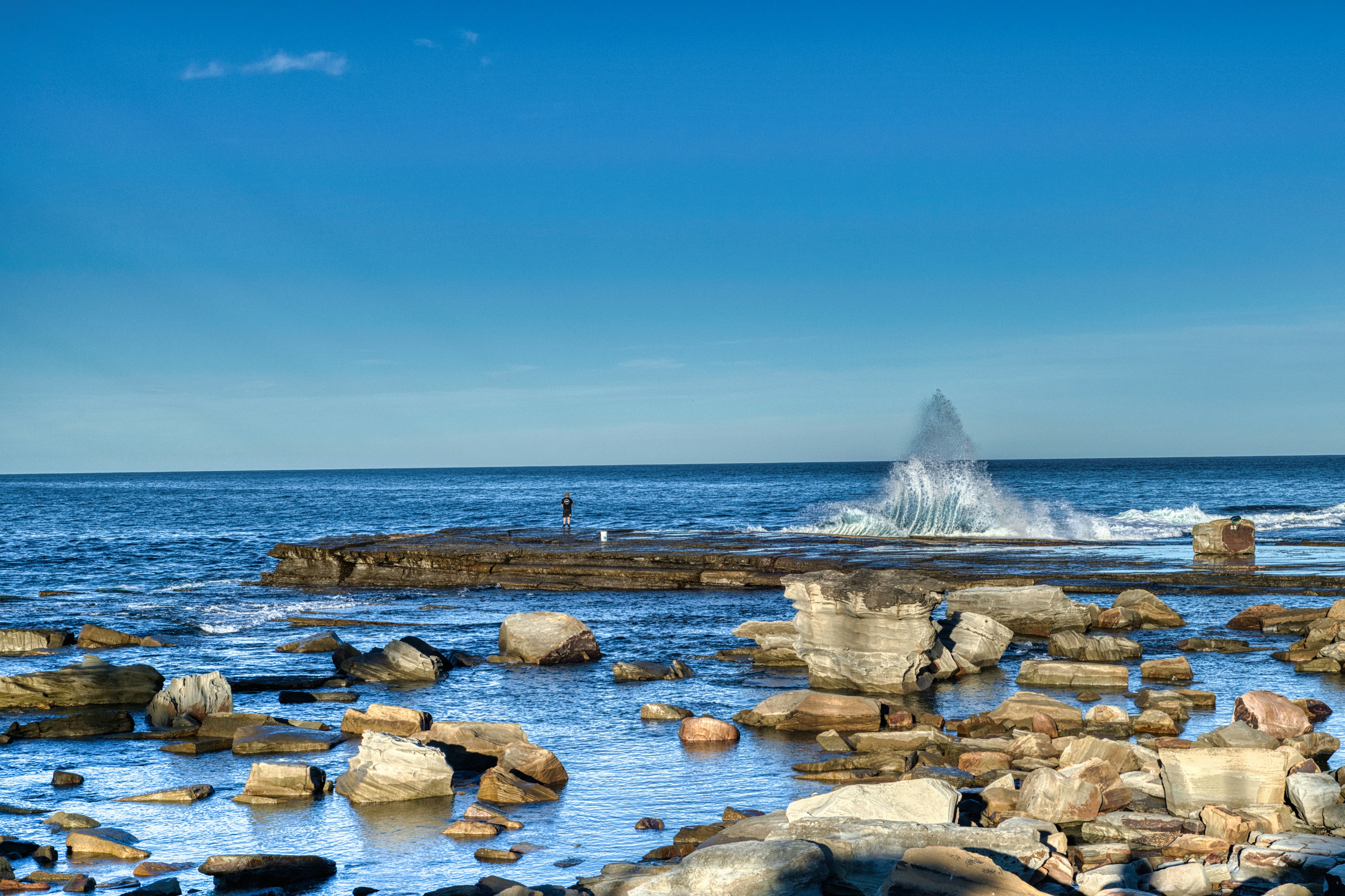A large body of water surrounded by rocks photo – Free Terrigal beach ...