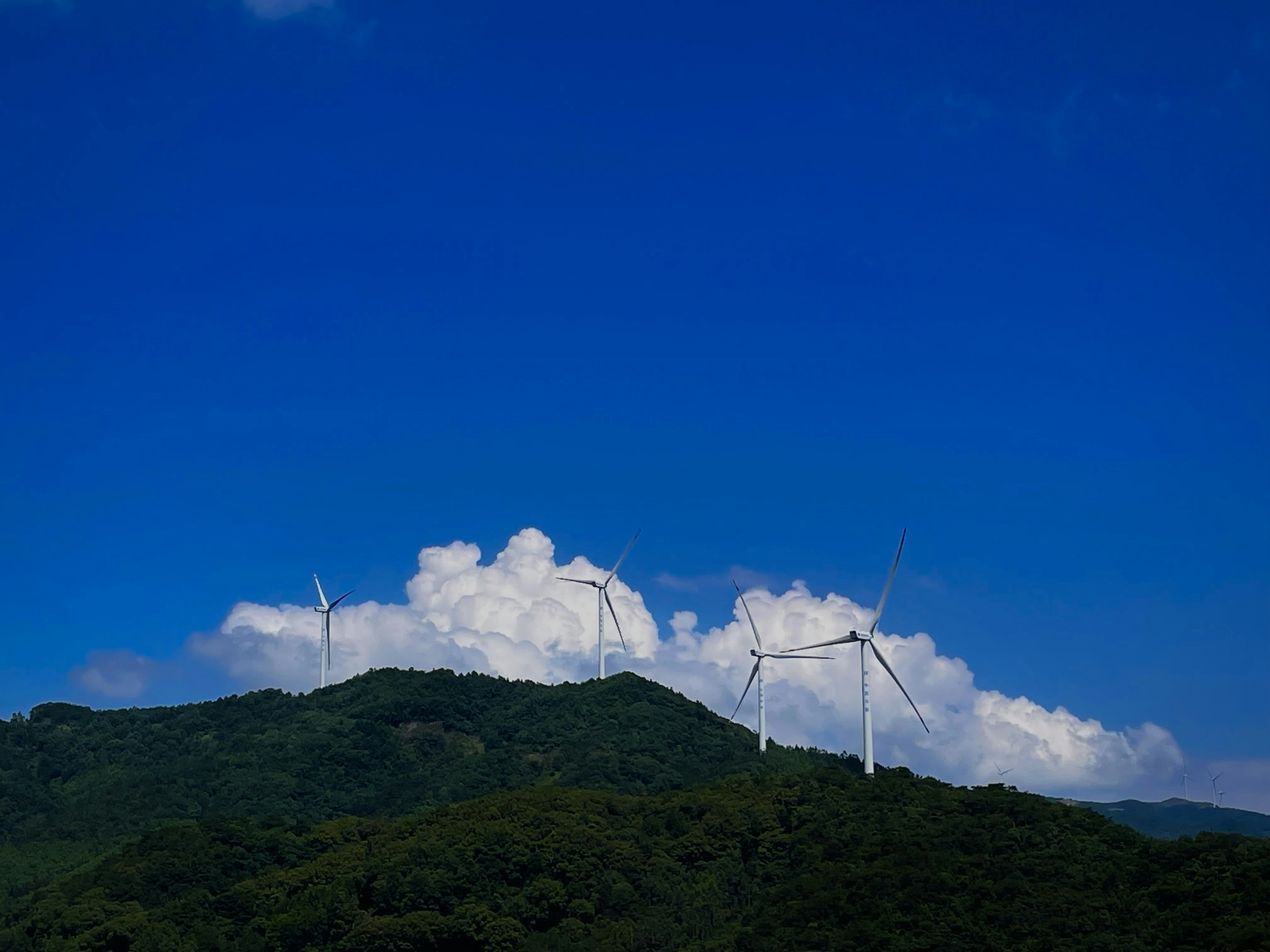 Wind Turbine Sentinels on a Green Ridge under a Cerulean Sky