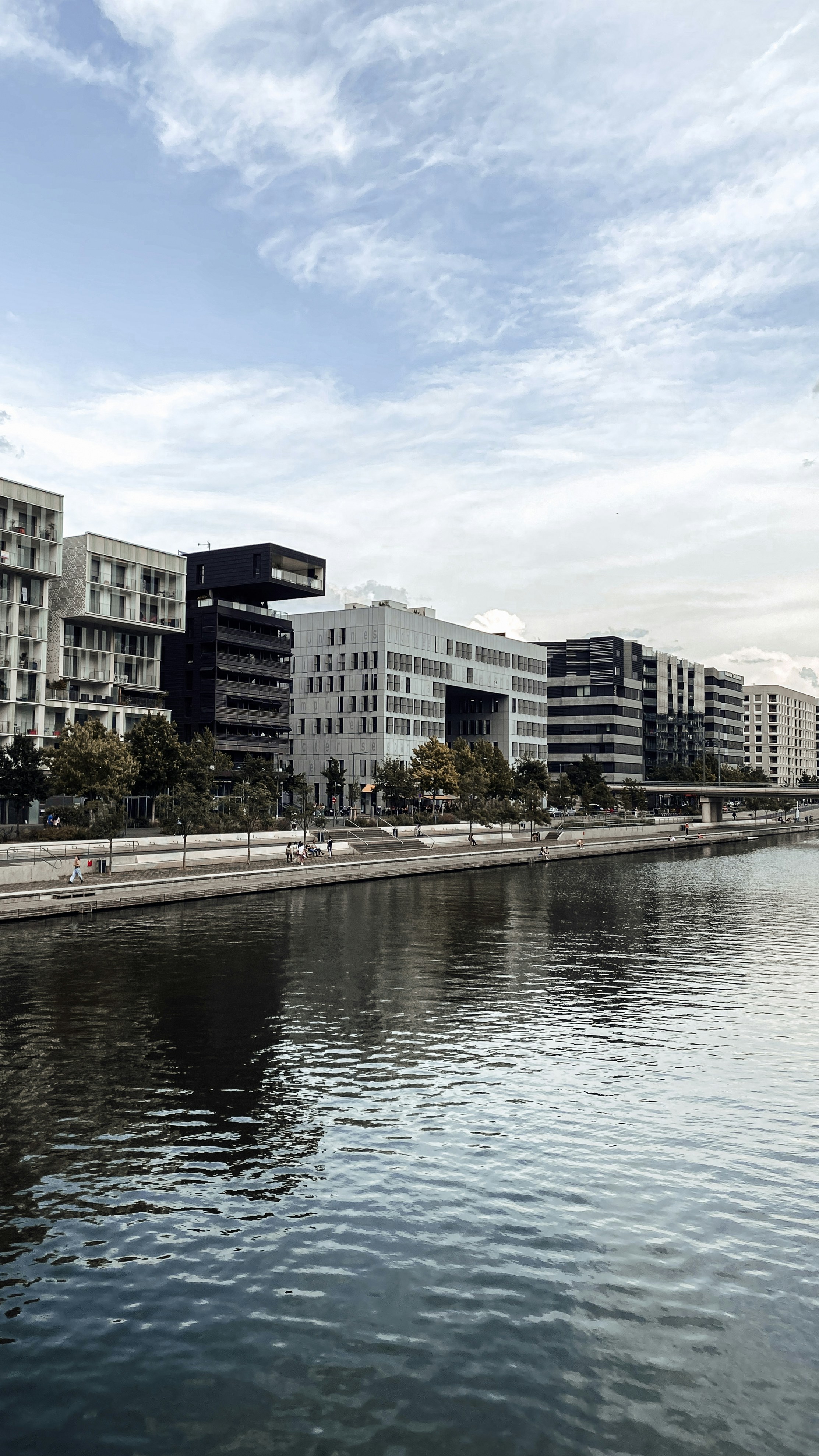 A body of water with buildings in the background photo – Free ...