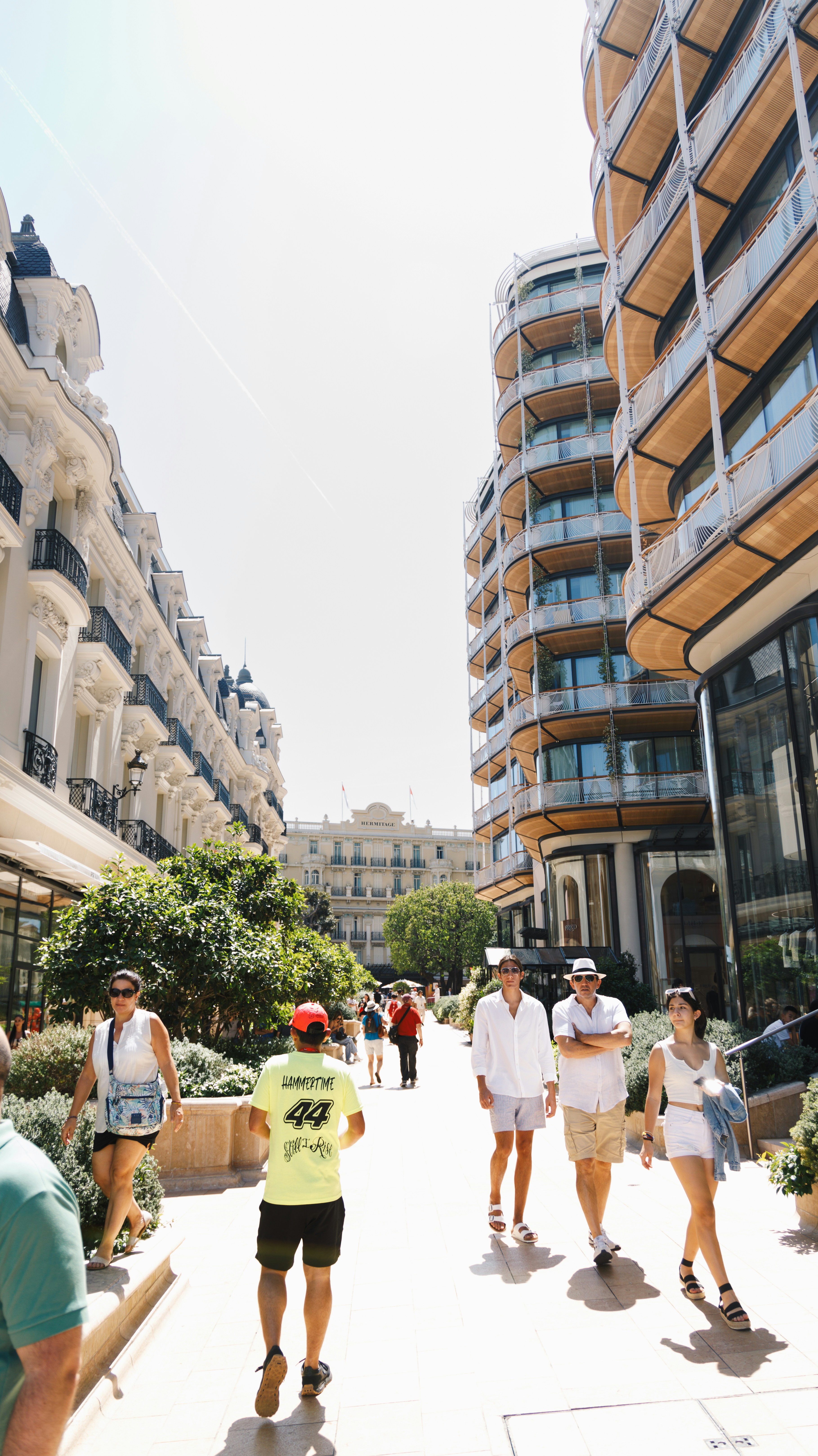 Sunlit Promenade Amid Modern and Classic Facades