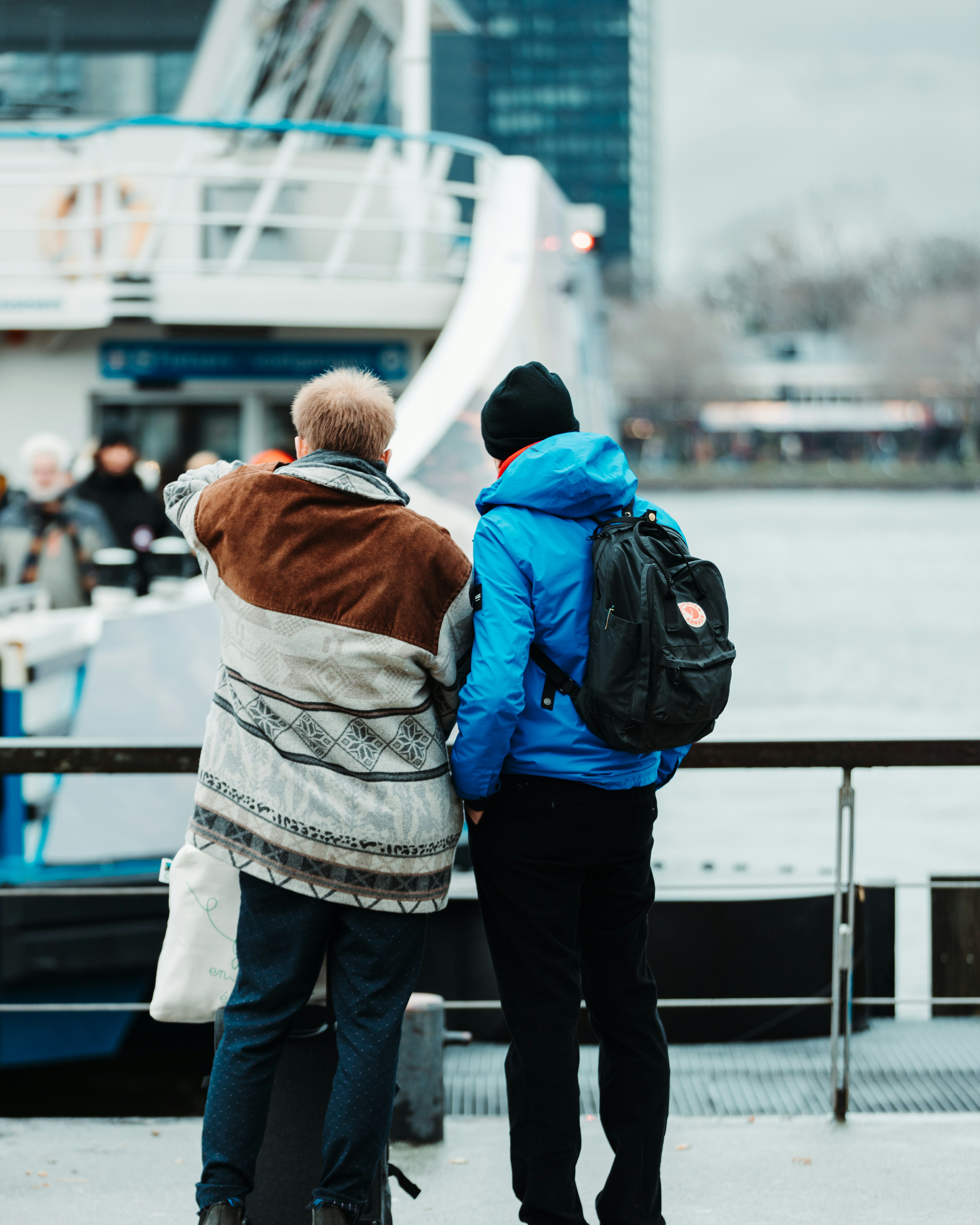 Two Friends in Colorful Outerwear Overlooking the Waterfront
