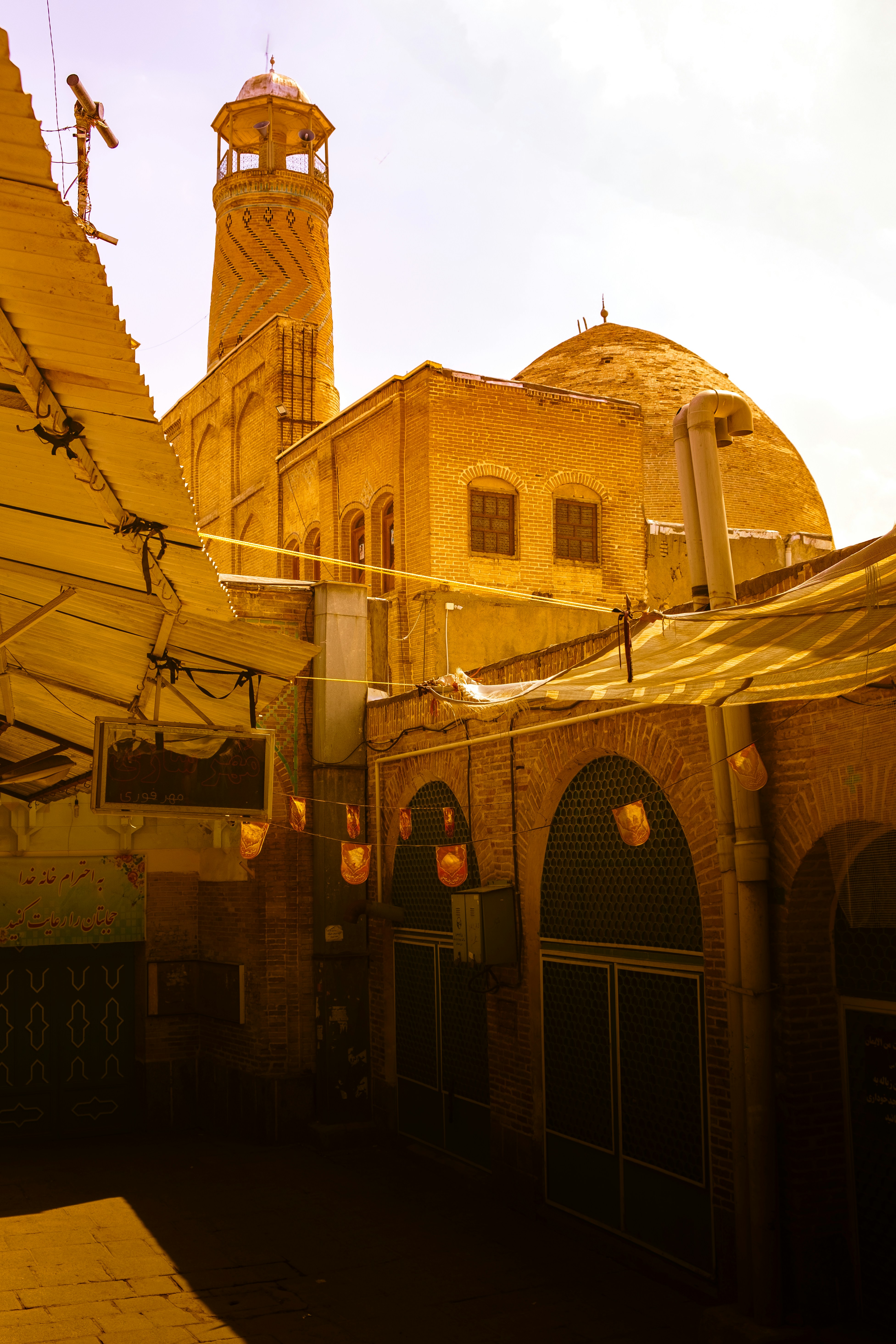 An old building with a clock tower in the background photo – Free Iran ...