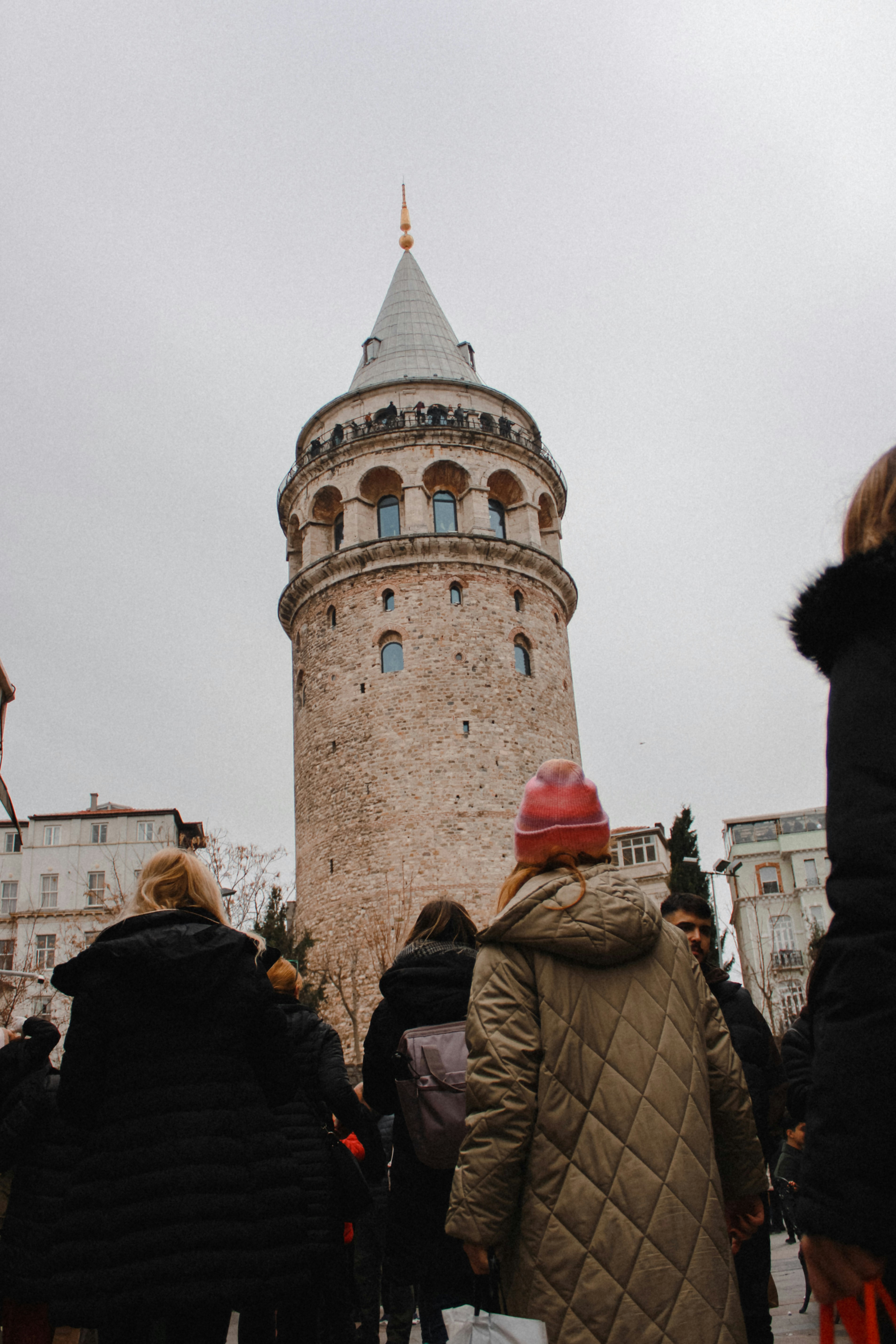 Tower of Time: A Crowd Gathers Before the Cylindrical Keep