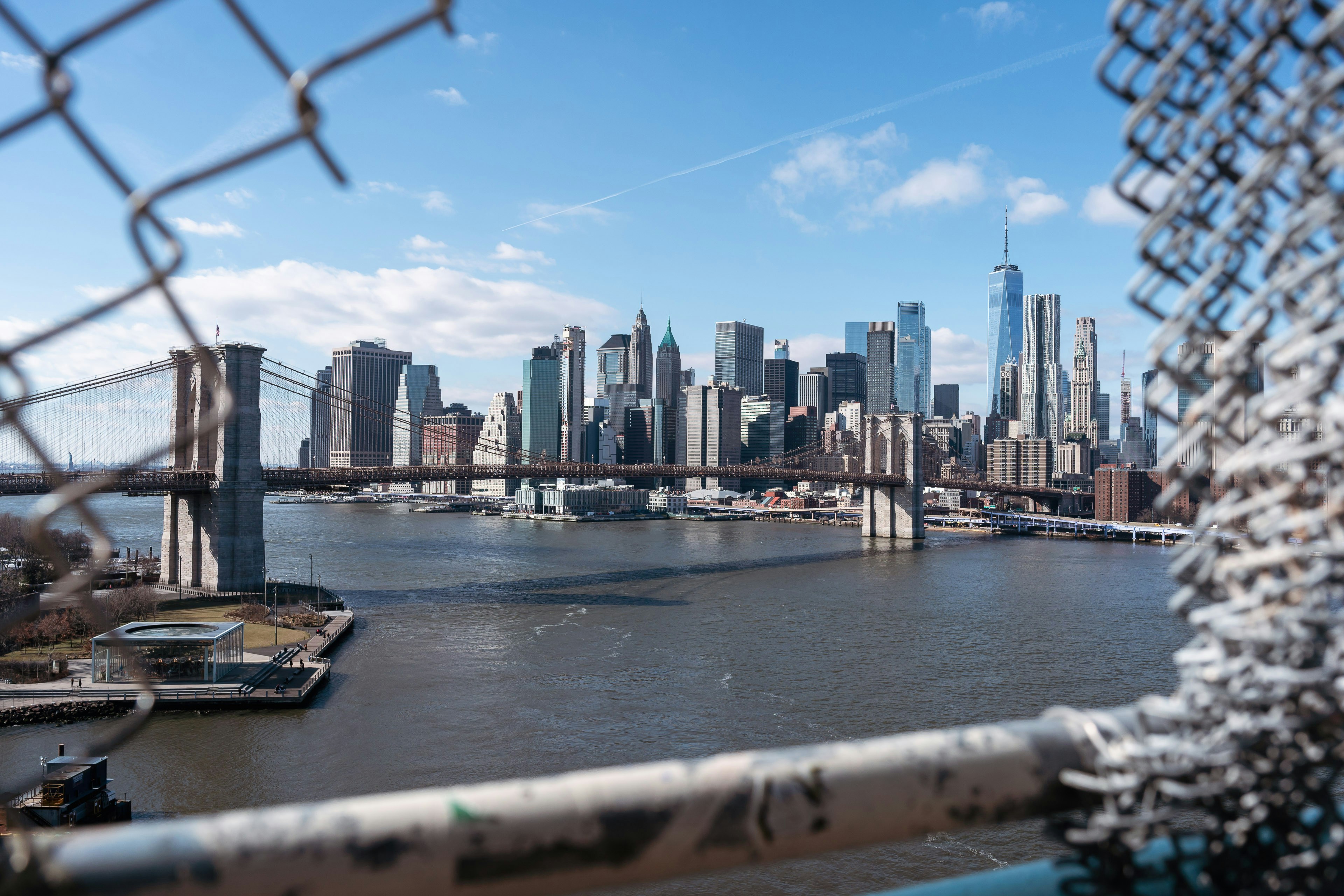 Fence-Framed Horizons: Manhattan's Skyline Across the East River