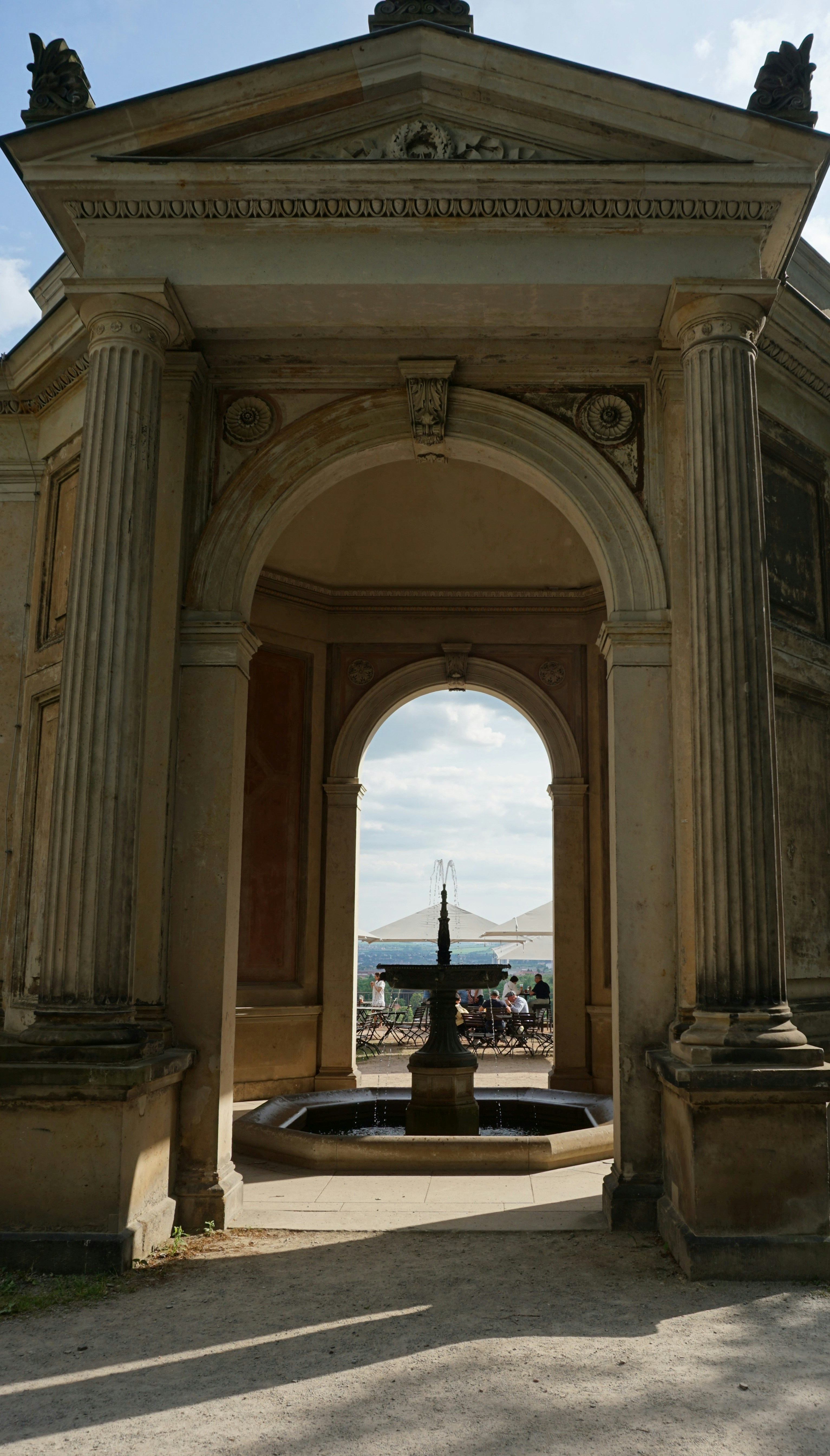 Archway to the Sea: A Sunlit Classical Frame