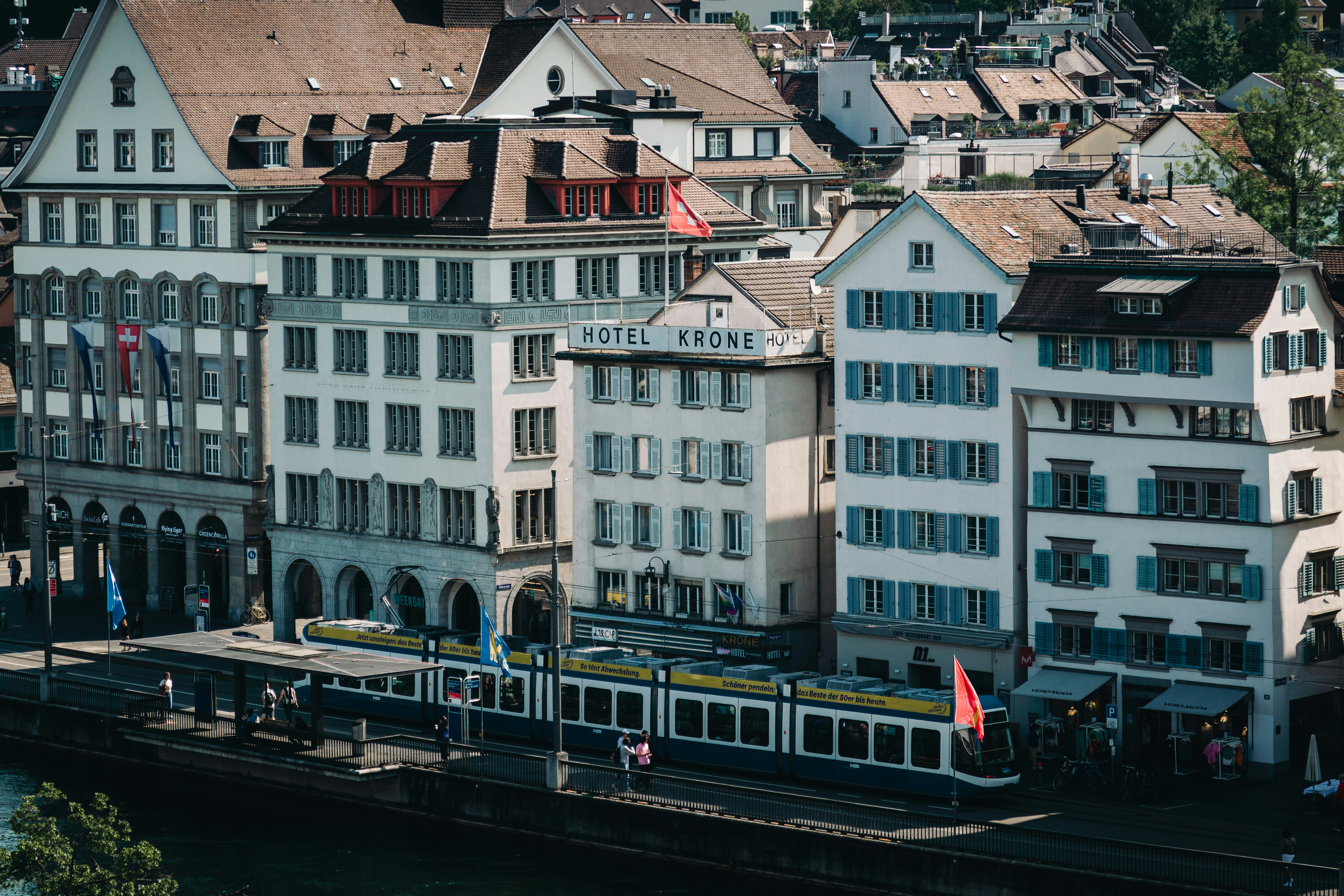 Hotel Krone by the River: A Swiss Facade Row Framed by a Passing Tram