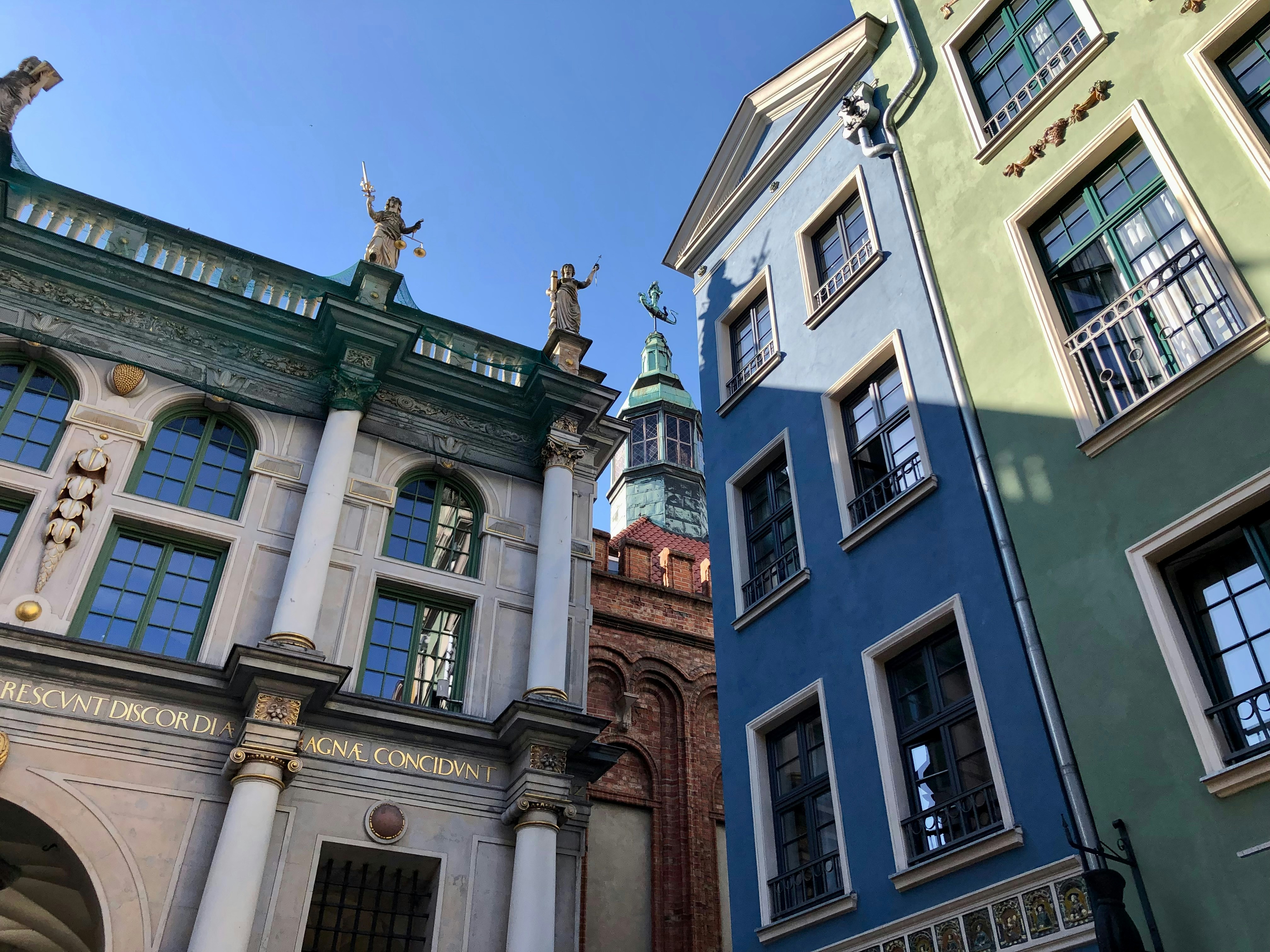 A row of buildings with statues on top of them photo – Free Gdańsk ...