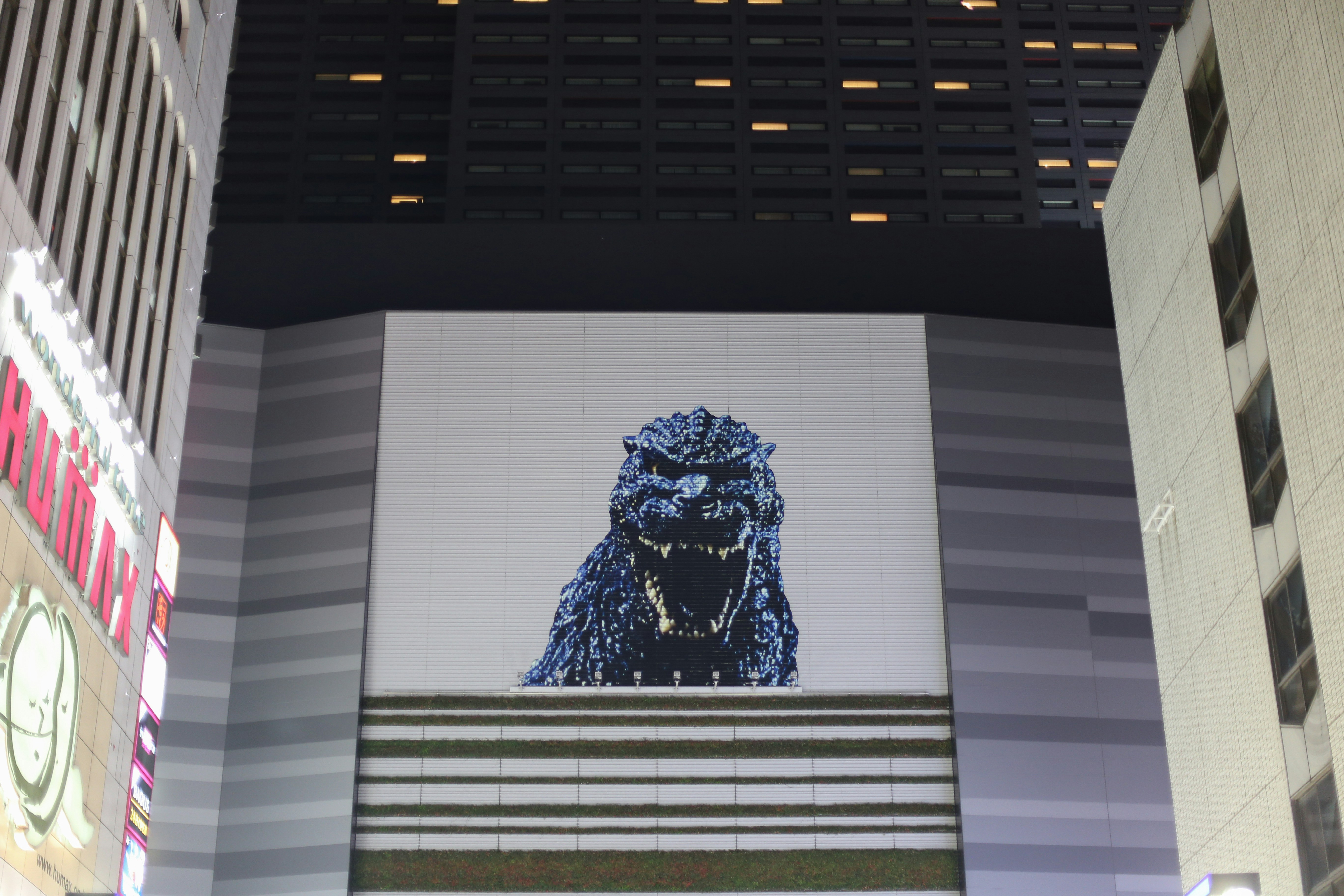 A giant screen of a godzilla on a building photo – Free 1 chome ...