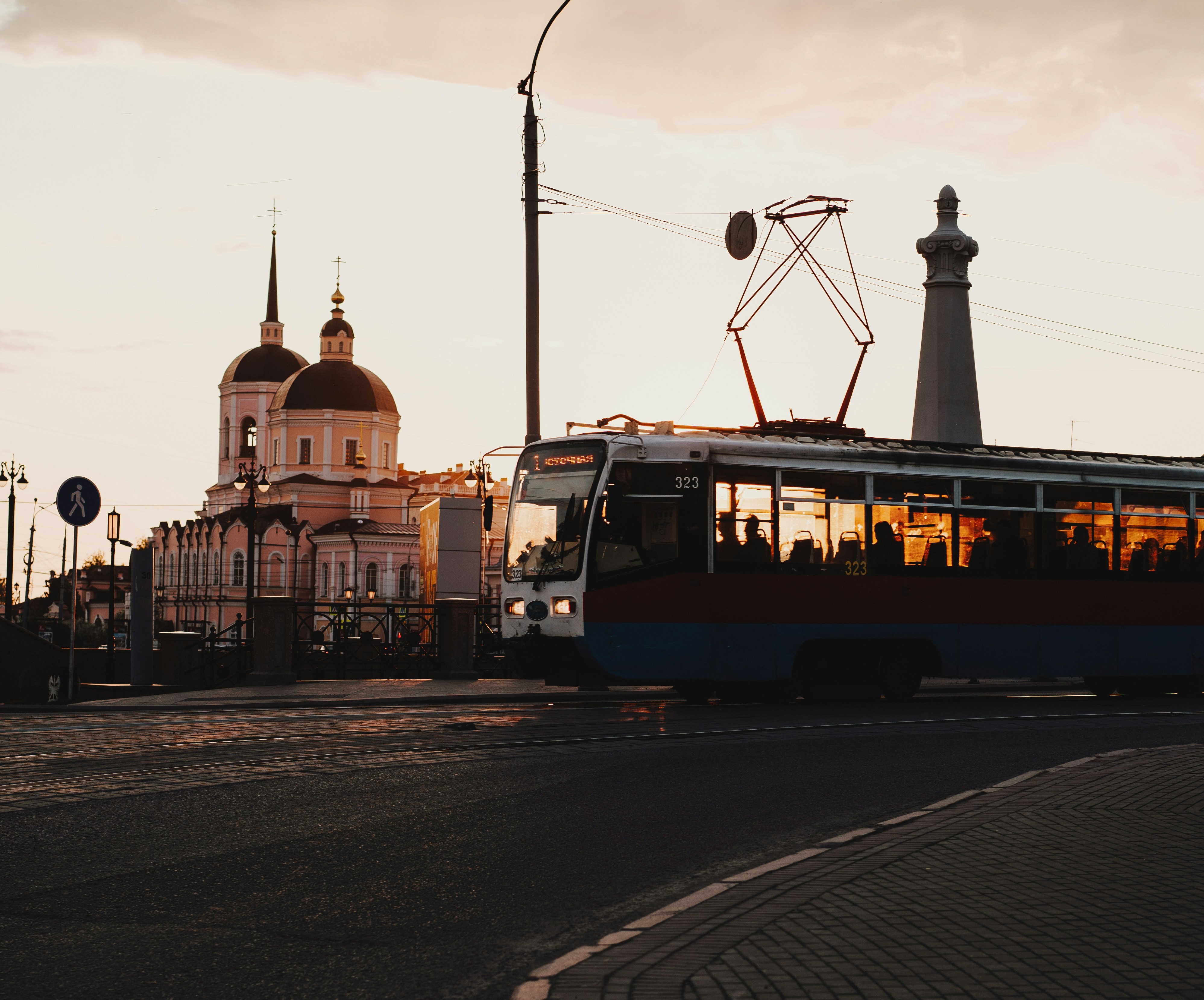  tram and historic church at sunset
