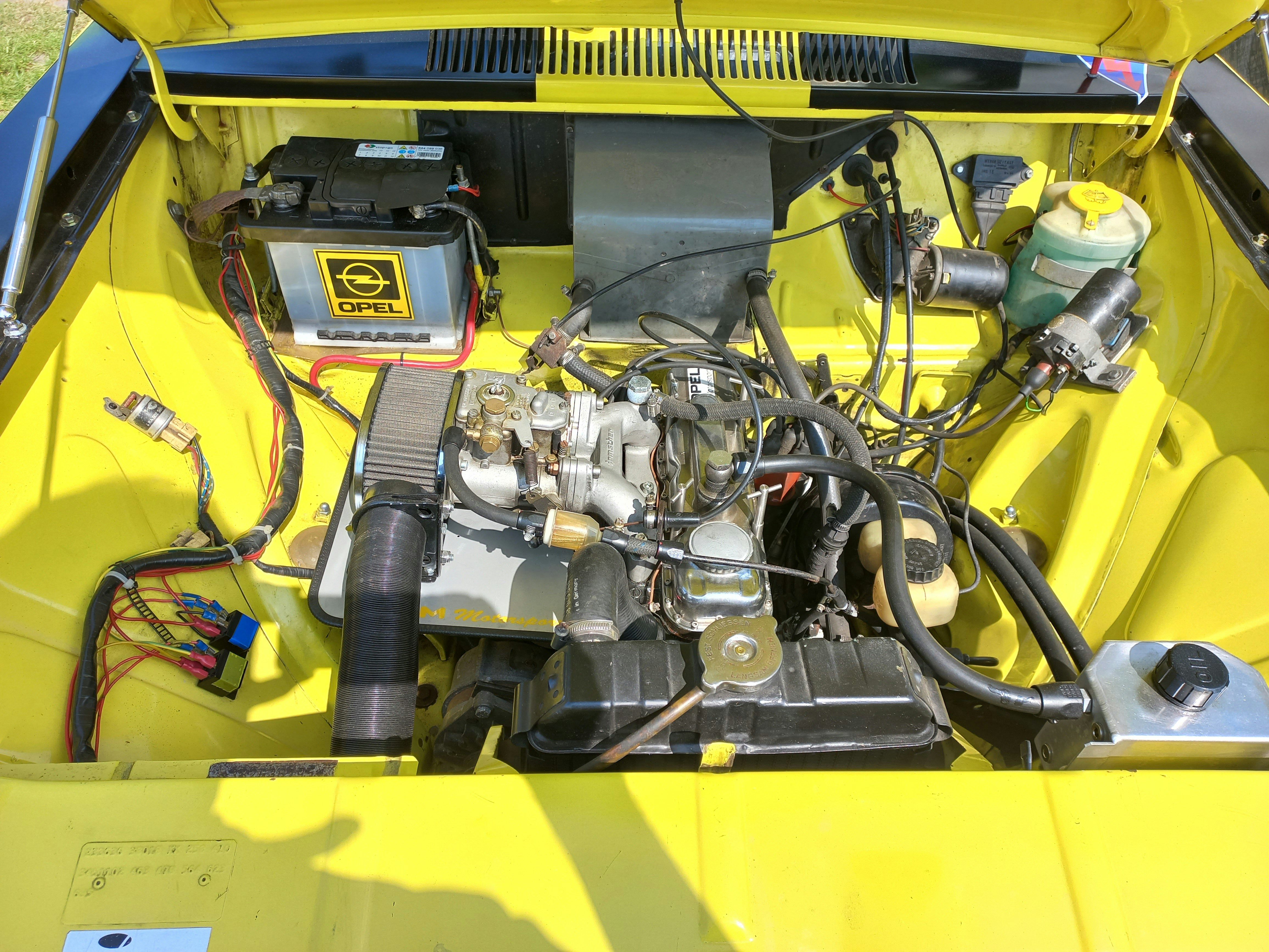 The engine compartment of a yellow car is shown photo – Free Car Image ...