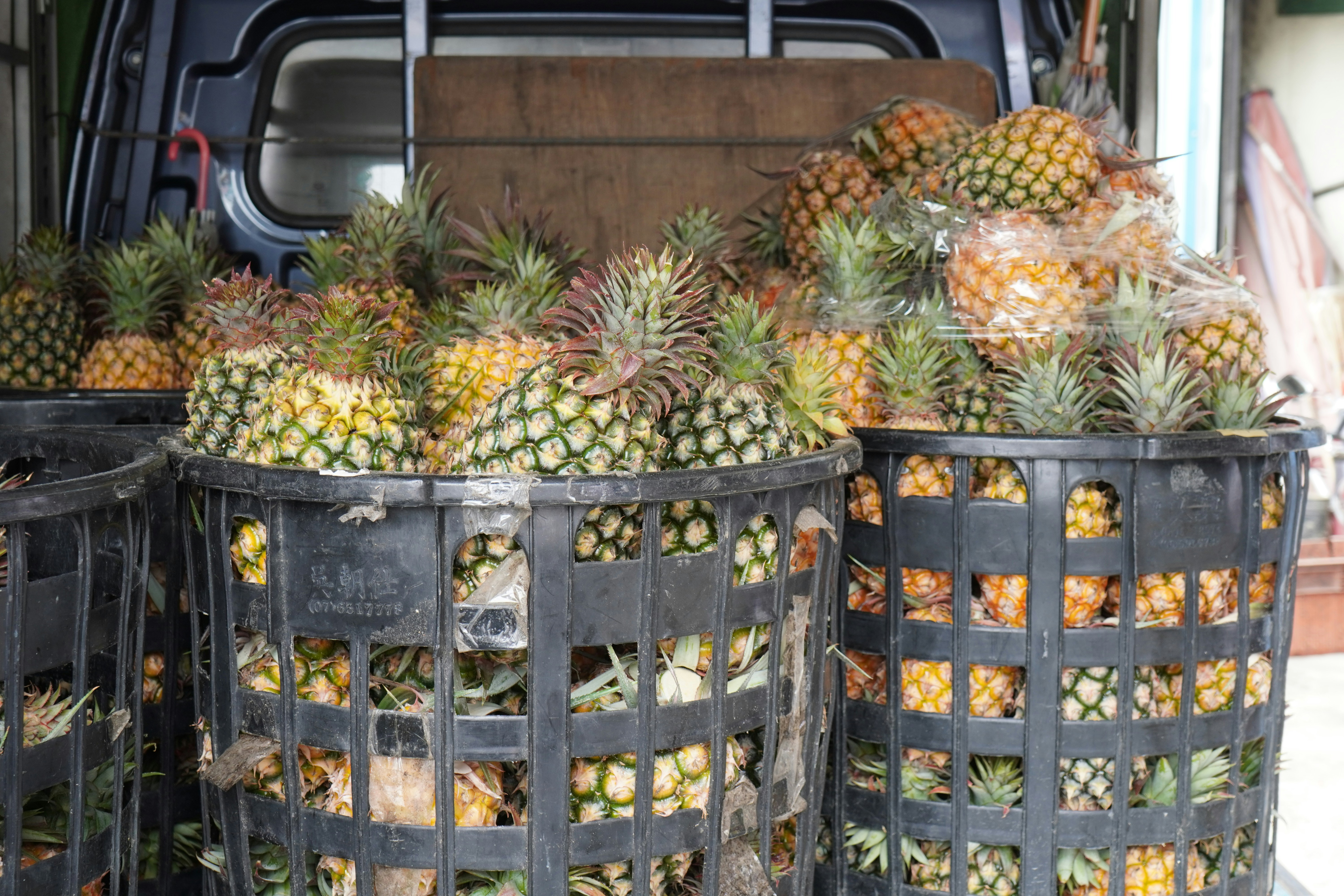 Piled Pineapple Banquet: Crates of Golden Pineapples in Transit