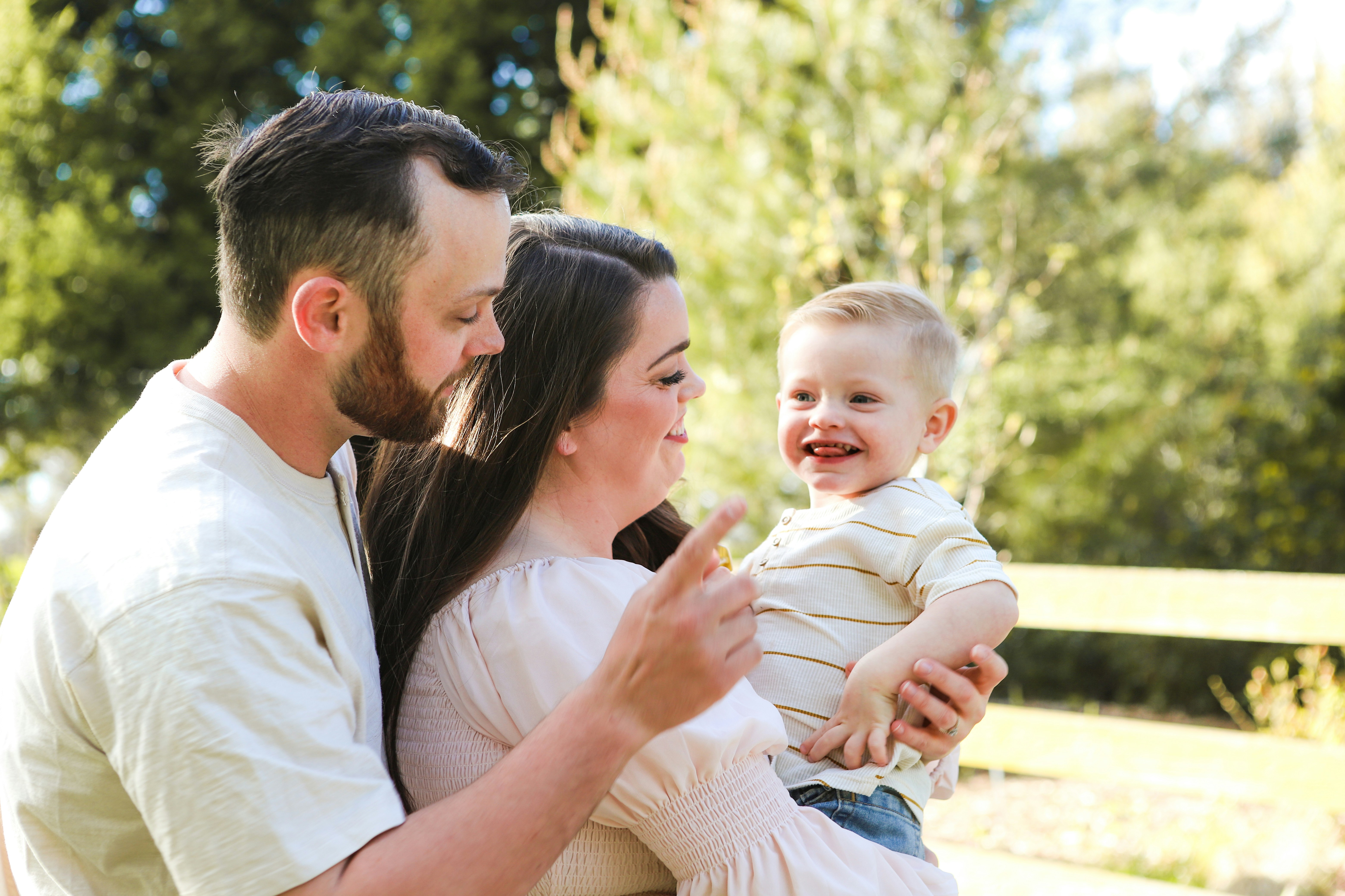 A man and woman holding a baby in their arms photo – Free Giggles Image ...