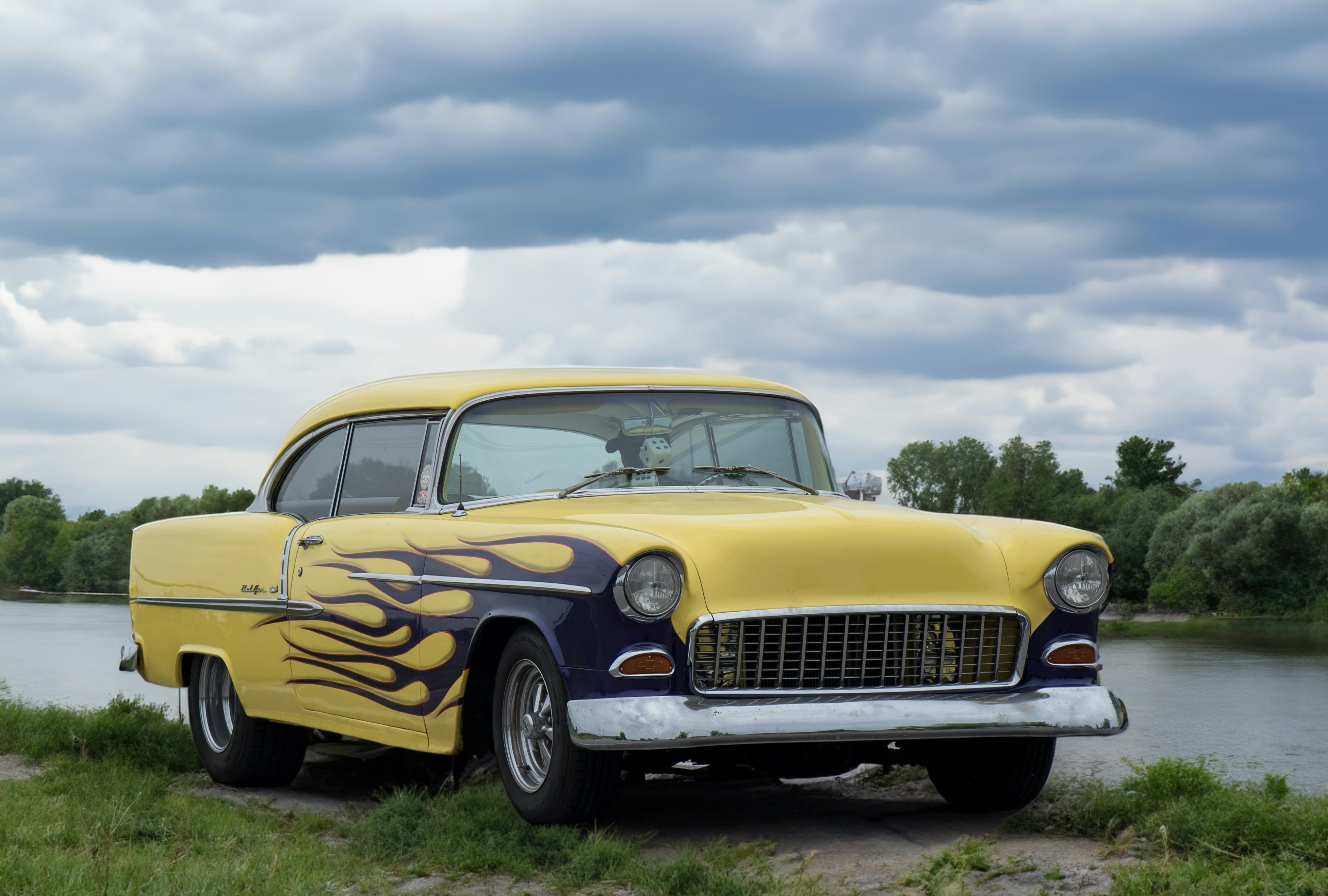 Flame-Lit Chrome: A 1950s Sedan Resting by Quiet Lake