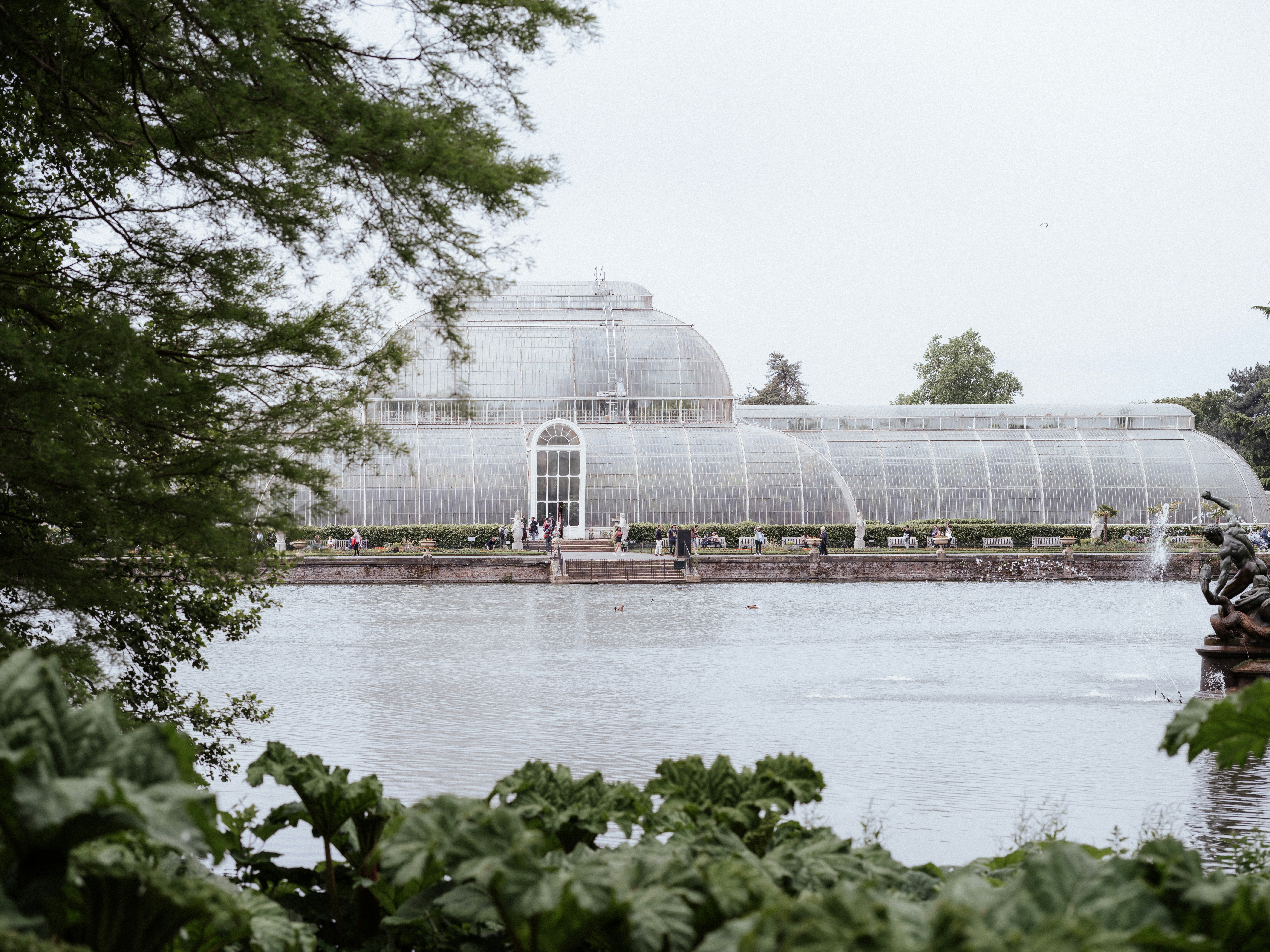 Glasshouse Over Quiet Lake: A Conservatory Vista