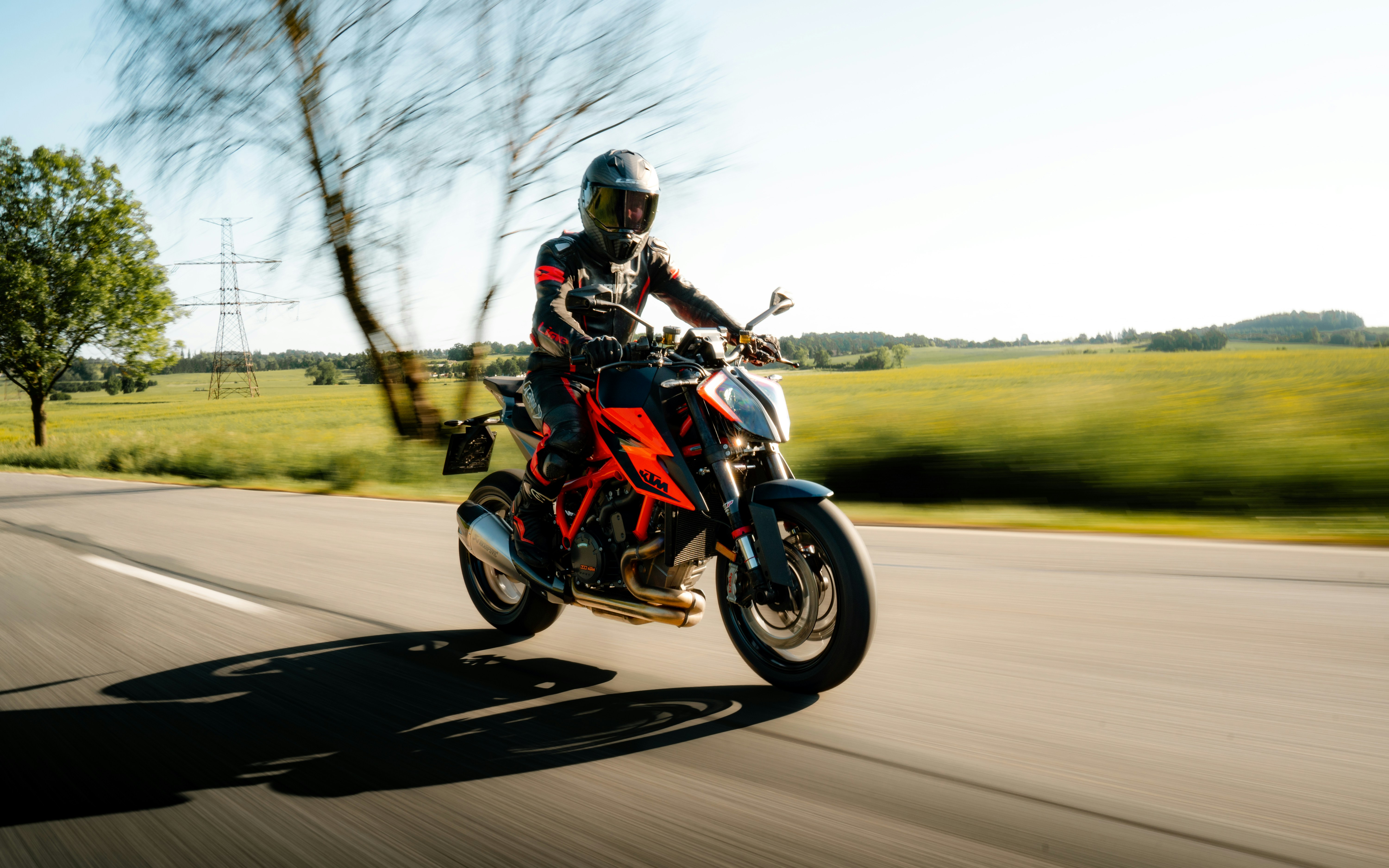 A man riding a motorcycle down a curvy road photo – Free Ktm duke Image ...