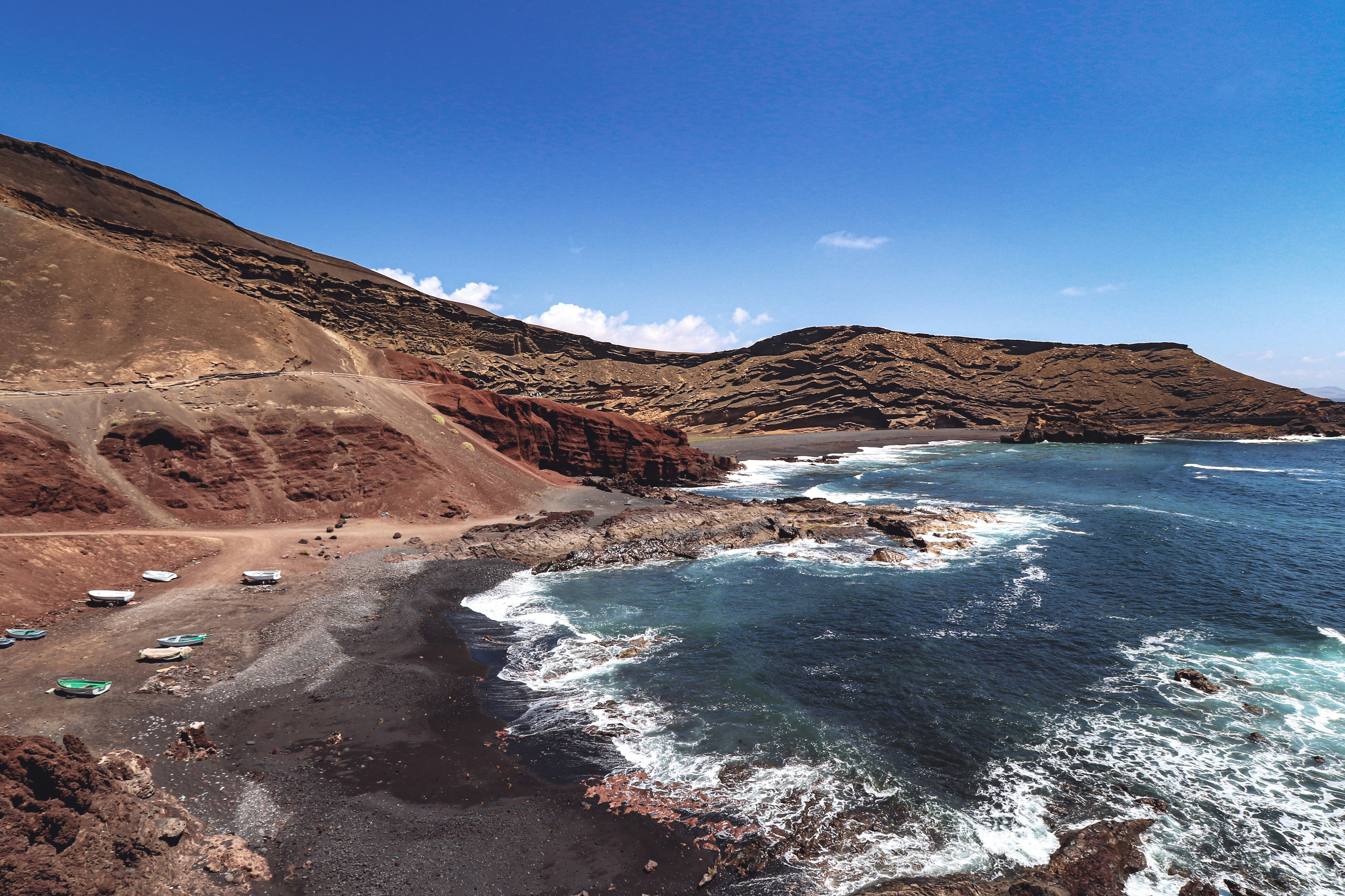 Crimson Cliffs, Cerulean Sea: A Coastal Portrait Along Rugged Shoreline