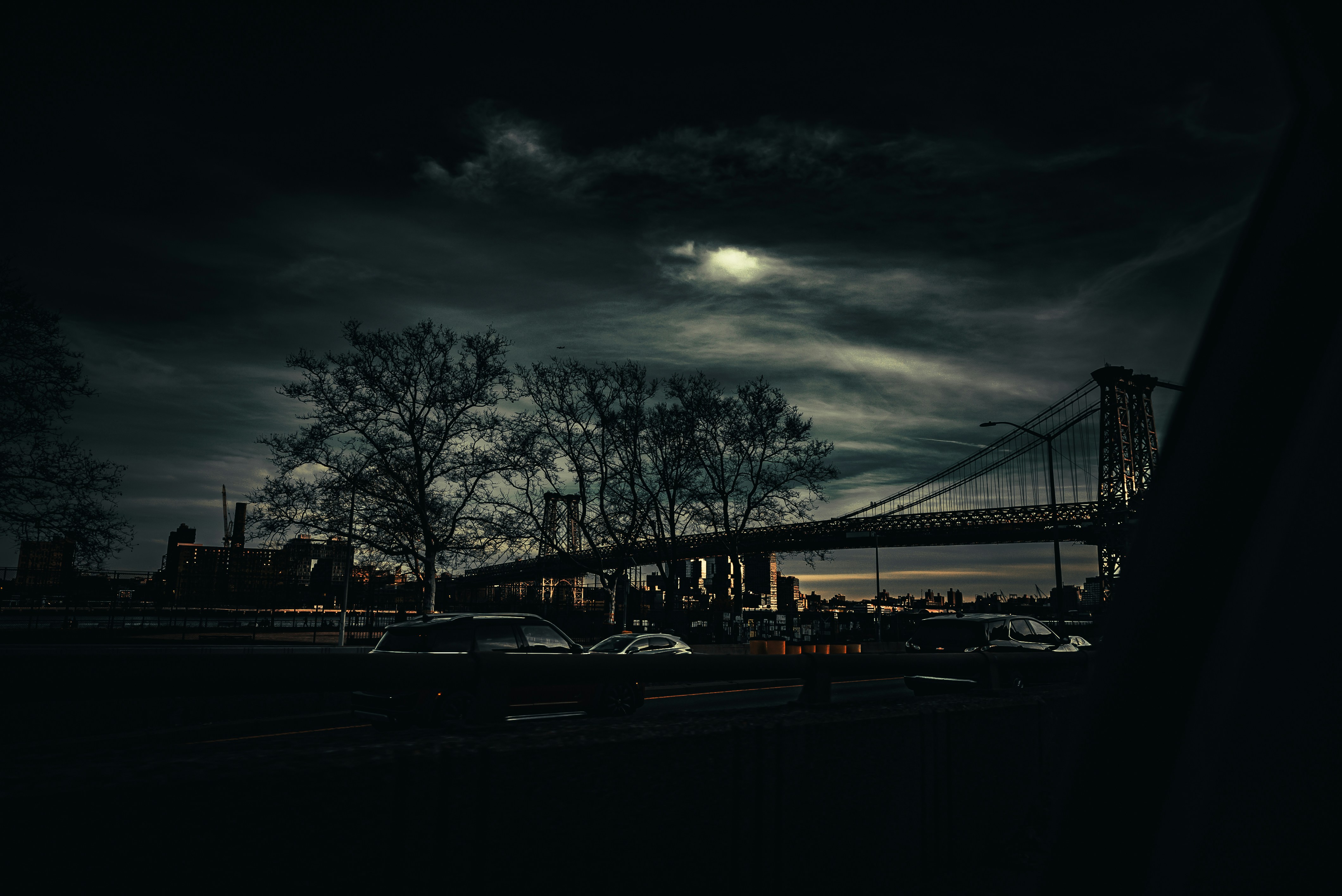 Driving by the Brooklyn Bridge on a cloudy day in New York.