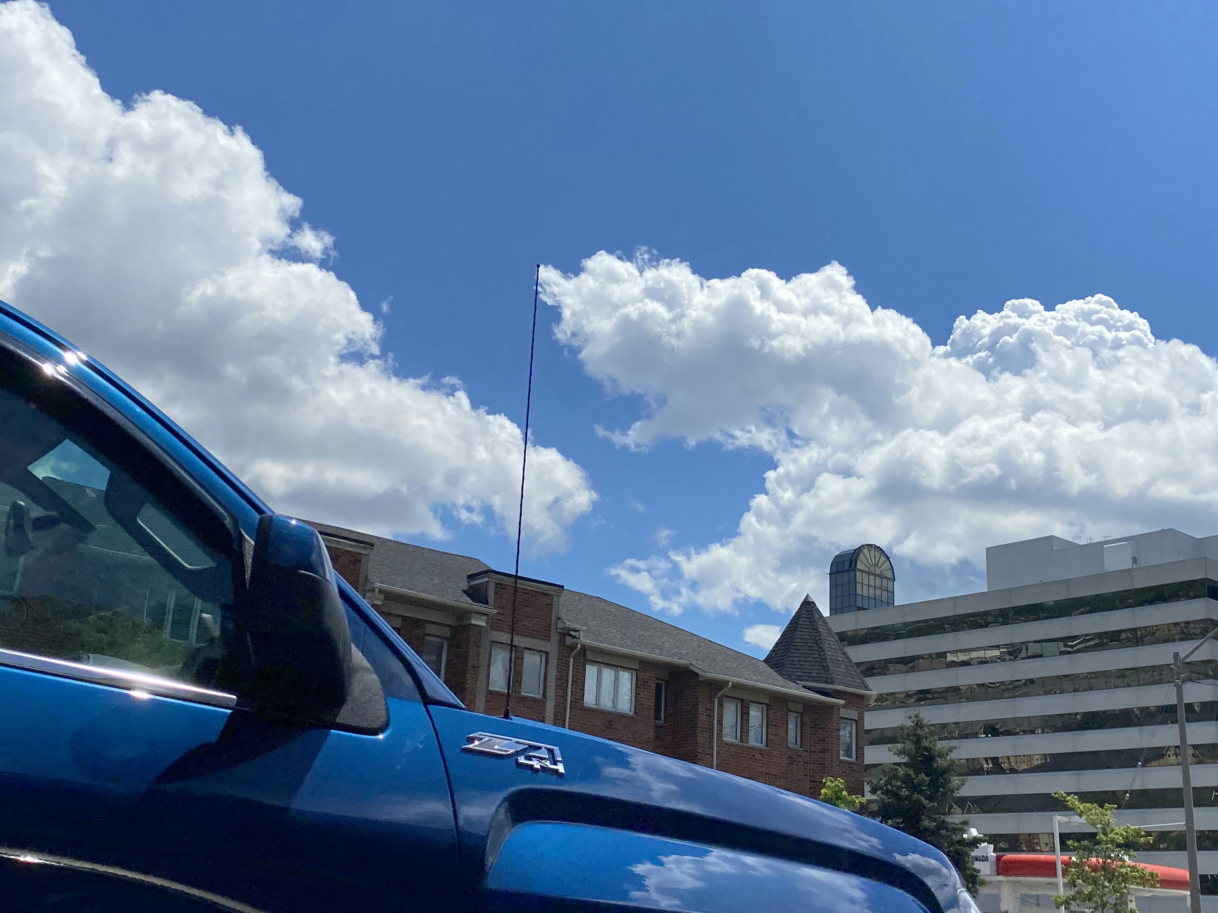 Azure Ford F-150 at the City Edge Under a Puff of Clouds