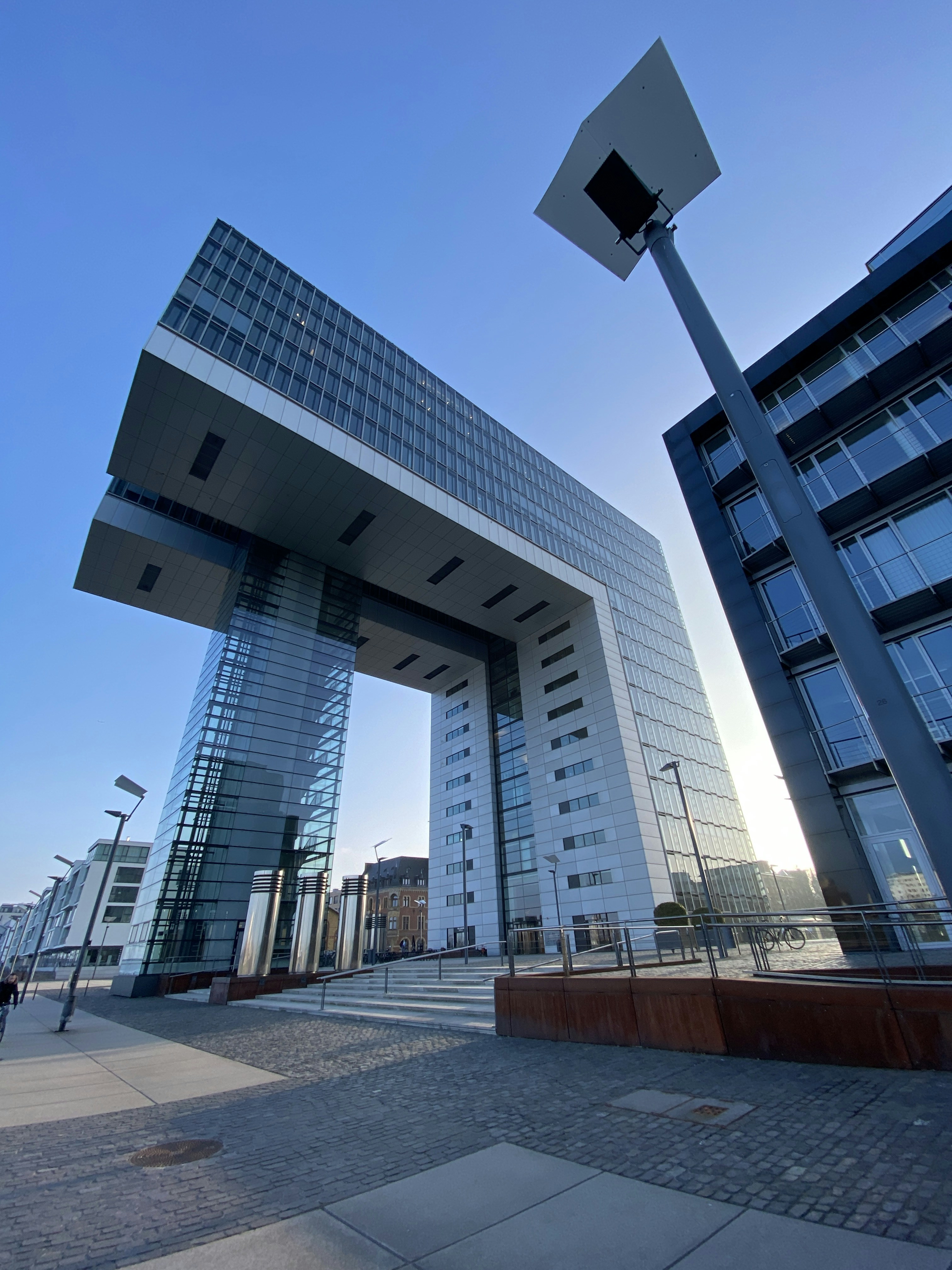 Leaning Glass Gateway: A Modern Arched Monument Reaching for the Sky
