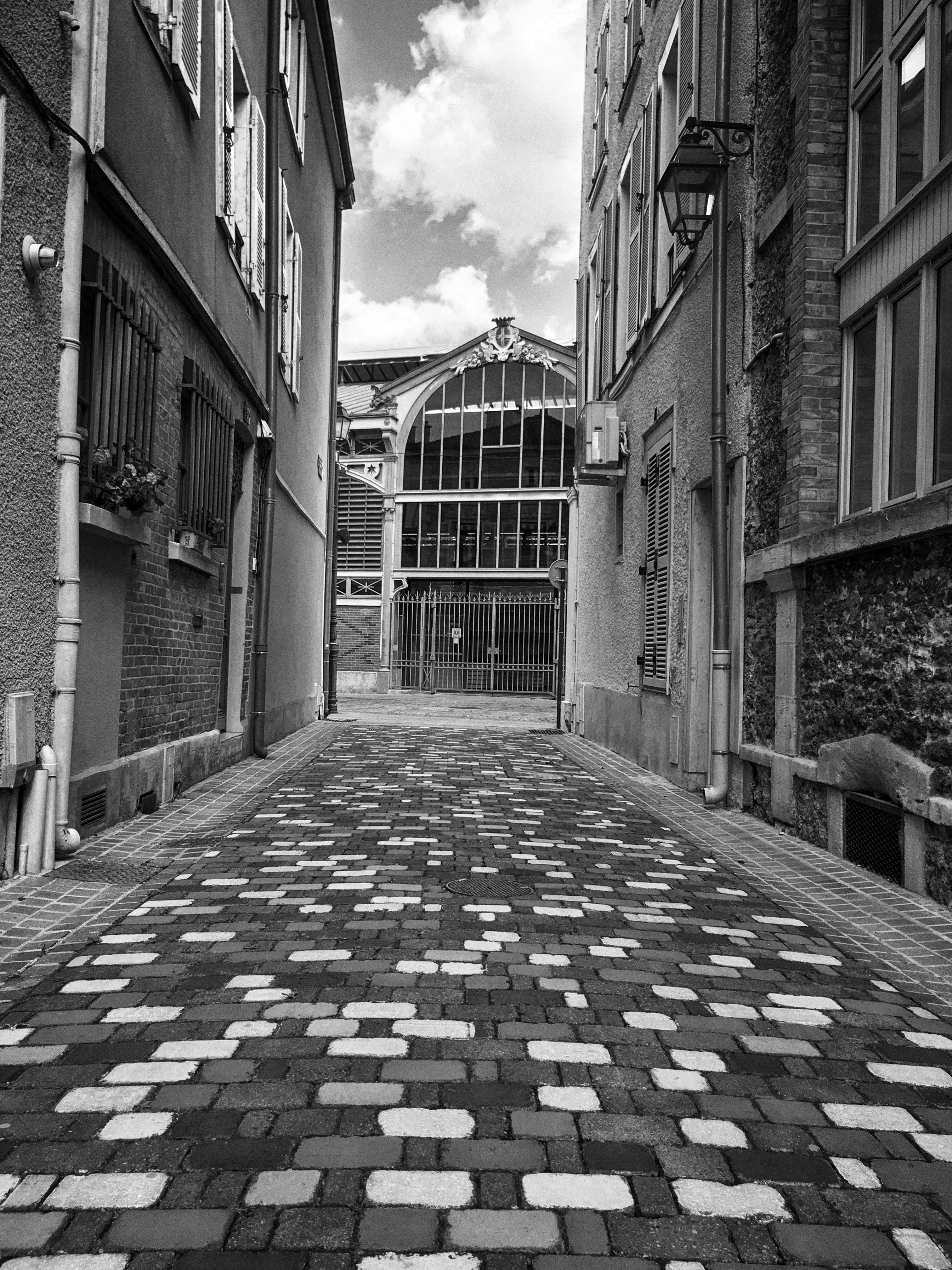 Gateway at the End of a Narrow Cobblestone Alley