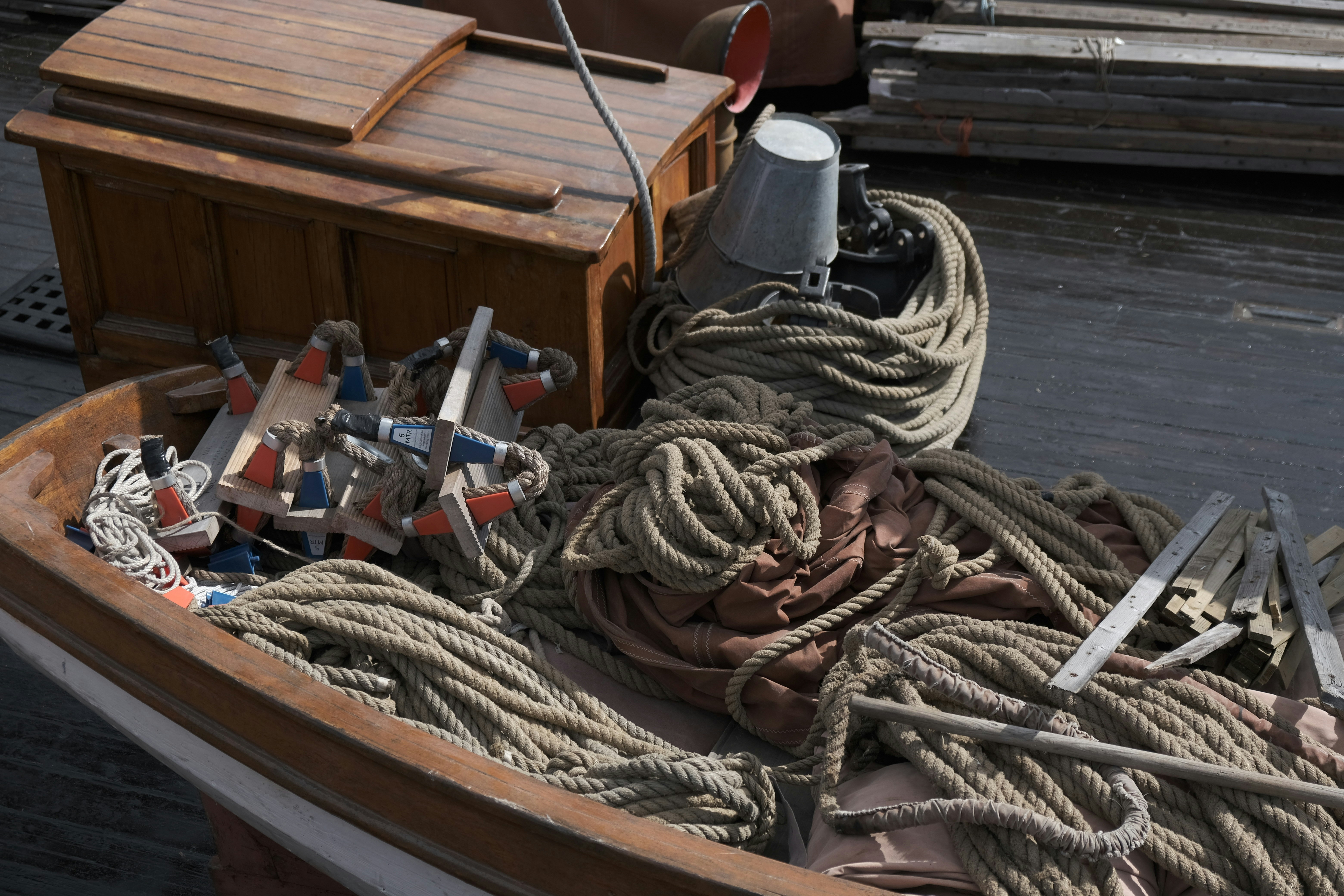 A wooden boat with ropes and other items in it photo – Free Stockholm Image on Unsplash