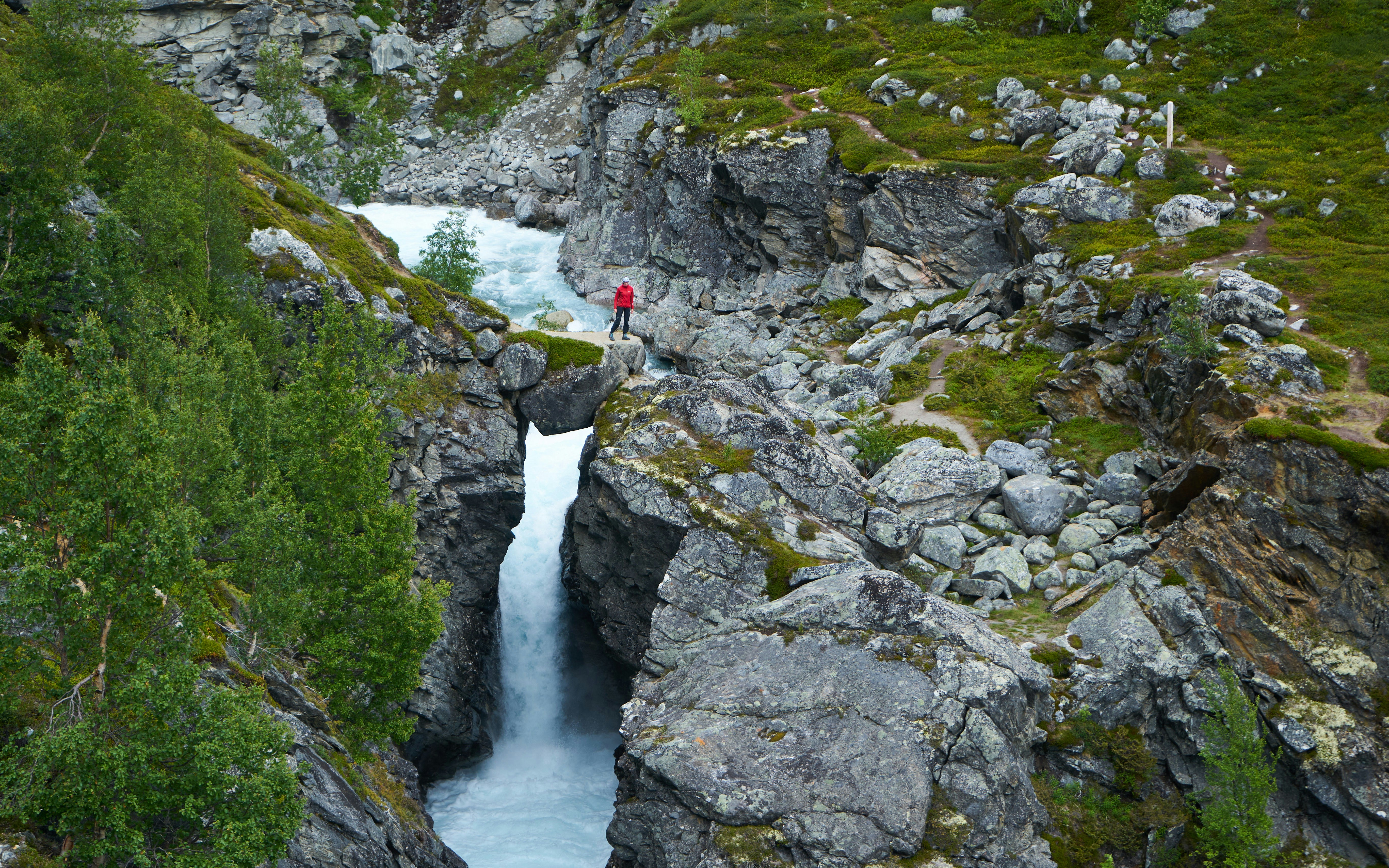 A person standing on top of a waterfall photo – Free Rock Image on Unsplash