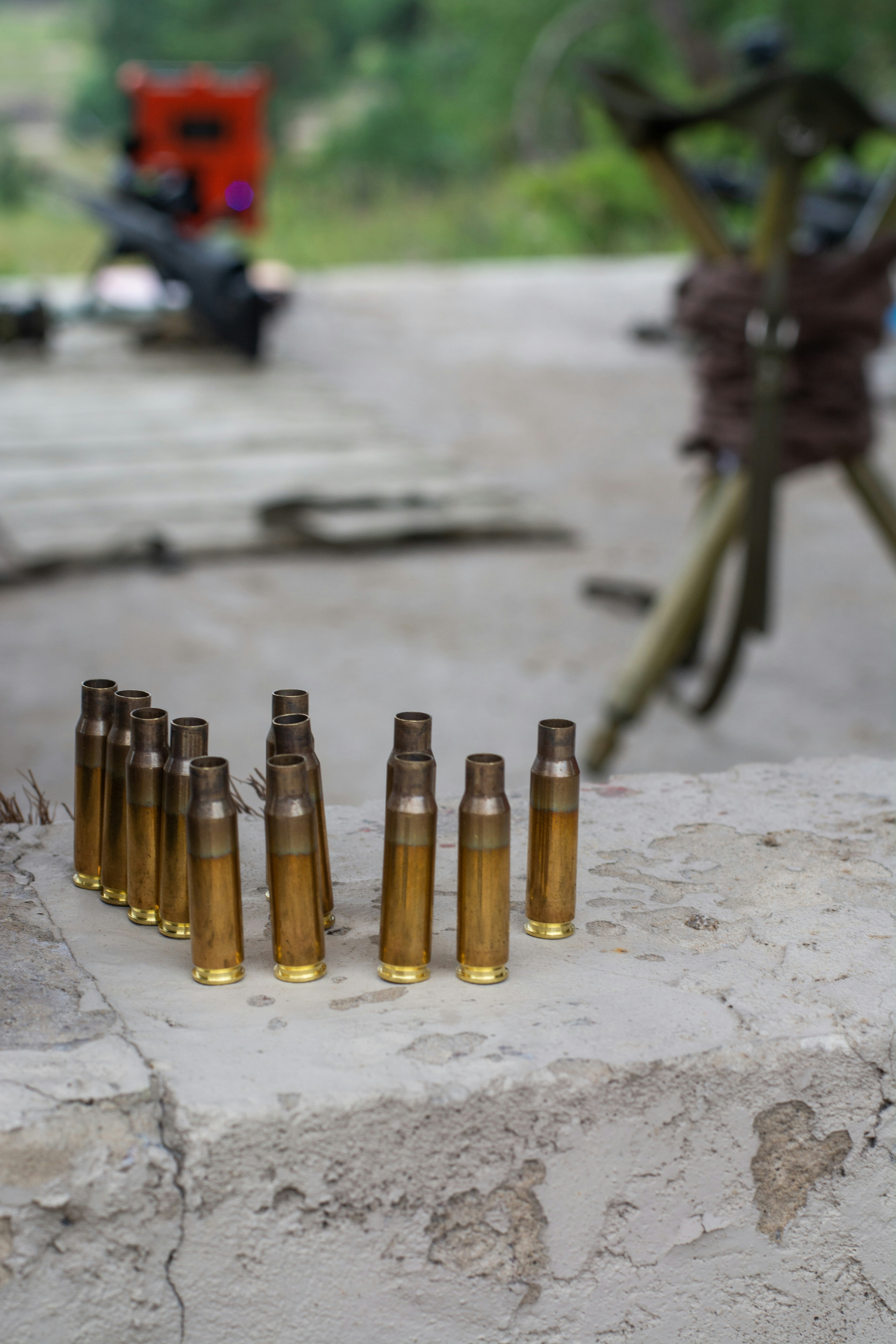 Brass Cartridges Stand Sentinels on Cracked Concrete as Distant Machinery Murmurs