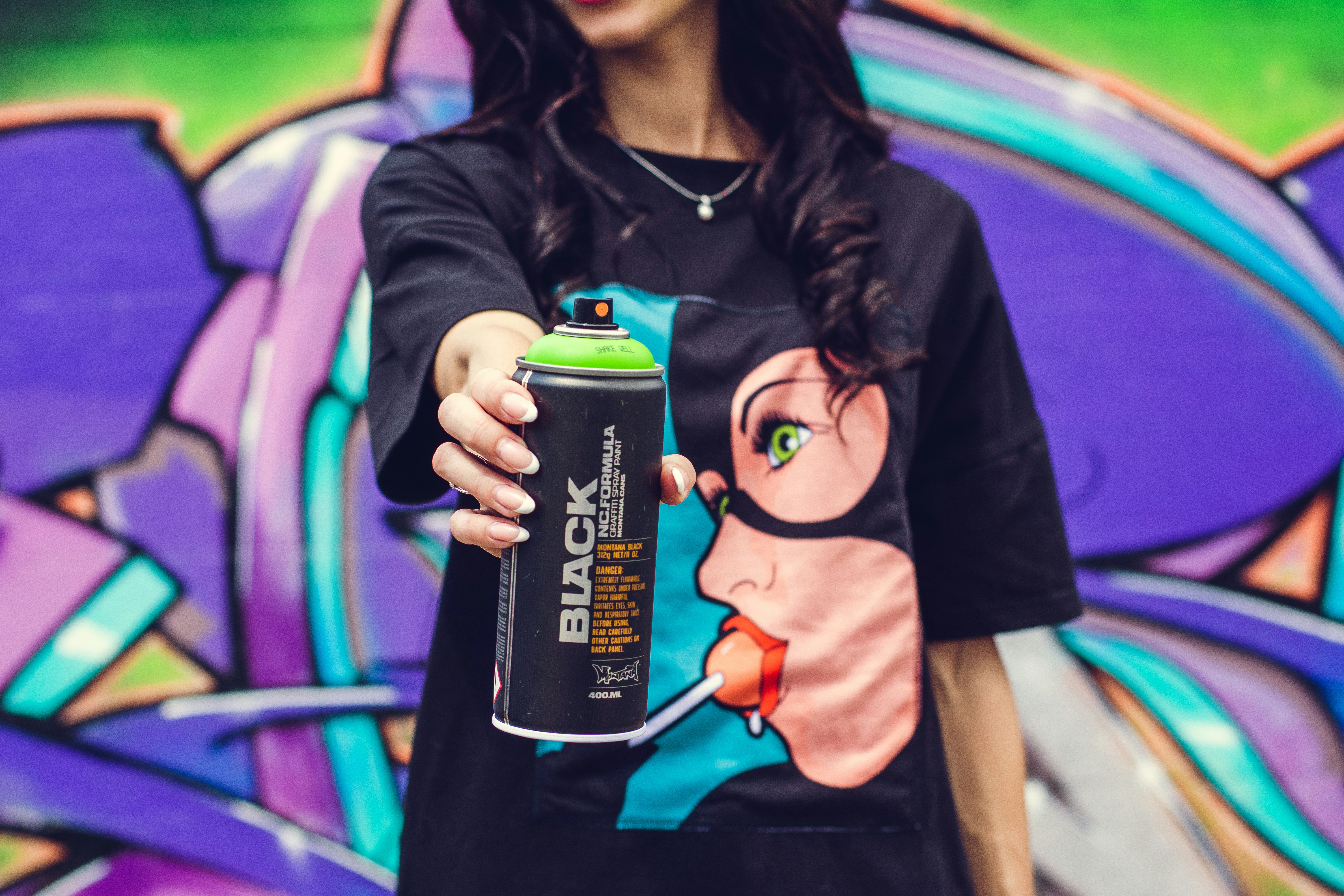 Spray Can Confrontation: Neon Graffiti Backdrop Framing the Face