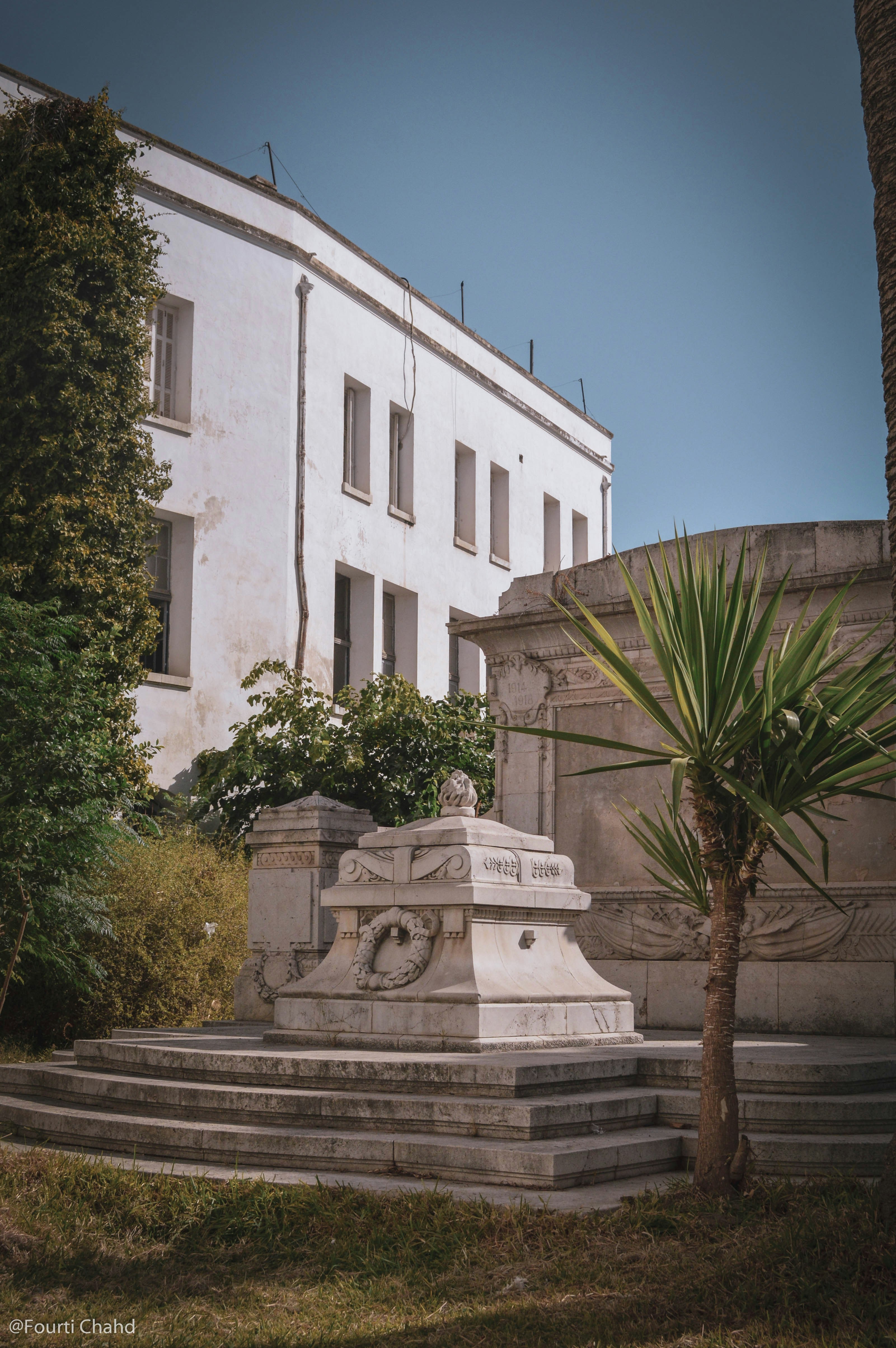 Monumental Quiet: A Sunlit Courtyard with a Marble Obelisk