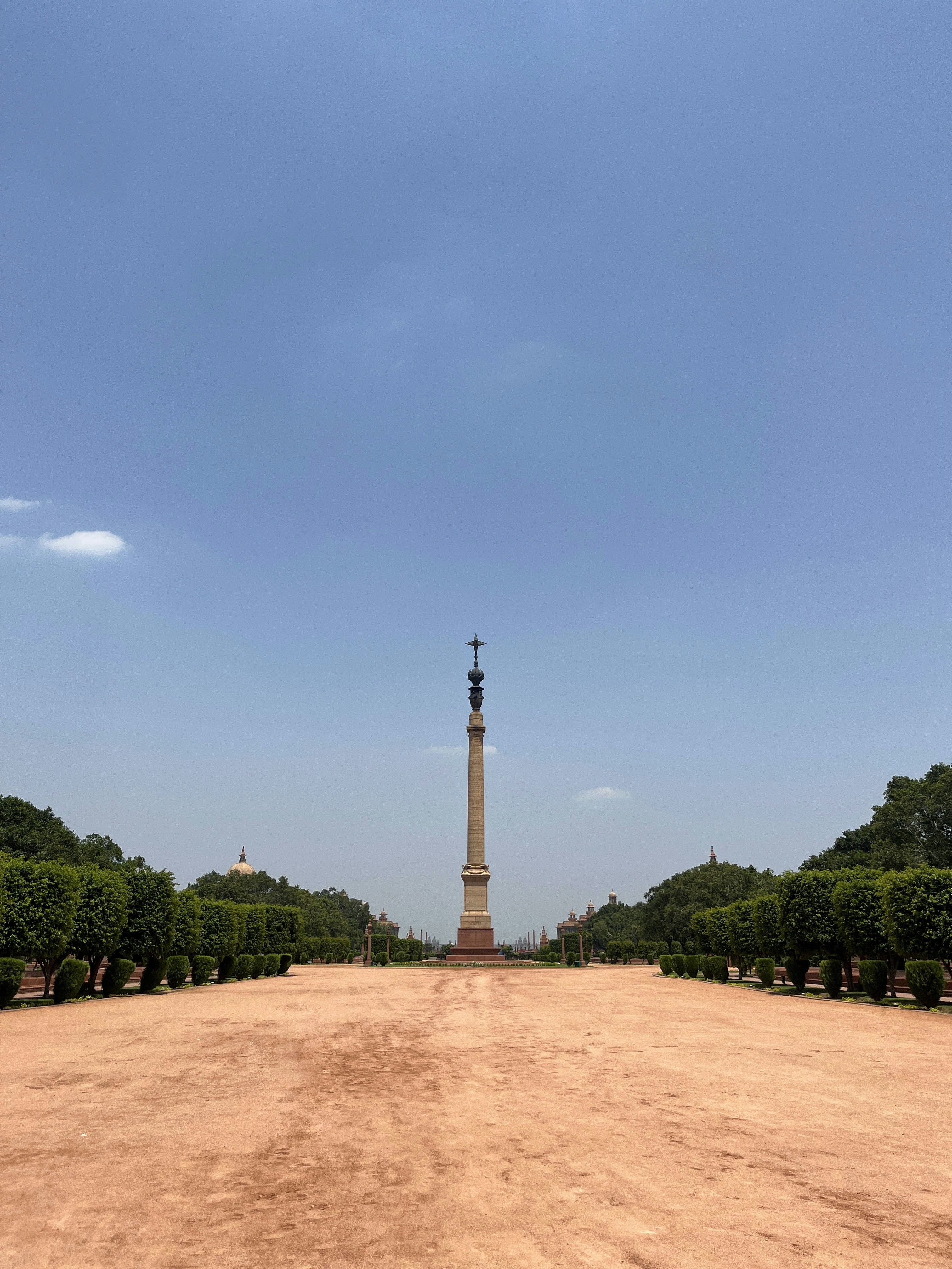 Symmetry at the End of the Avenue: The Obelisk Framed by Pruned Greenery