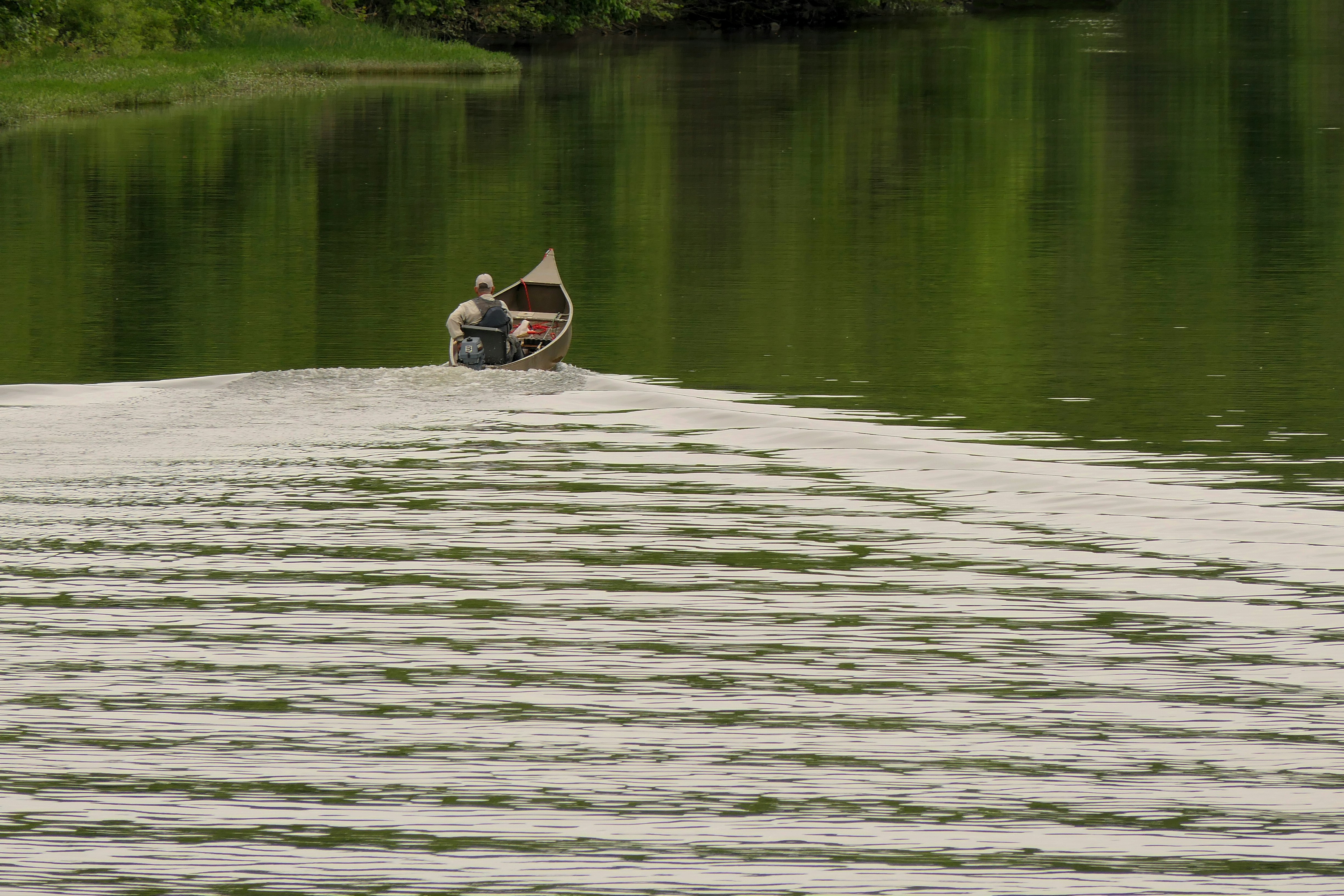 Emerald Wake: Two Paddlers Glide a Quiet Lake