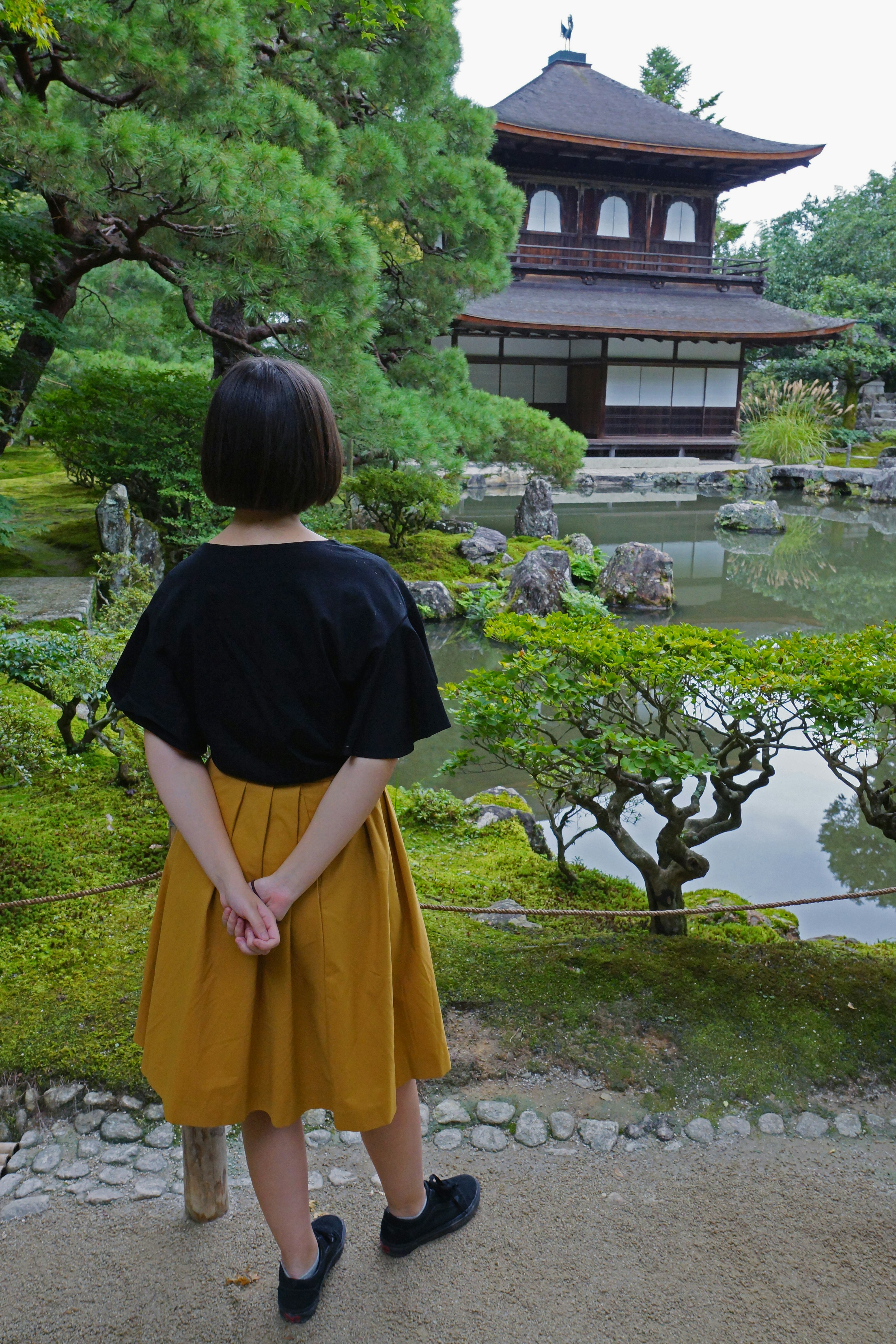 Paused in the Garden: A Quiet Portrait Before the Japanese Pavilion