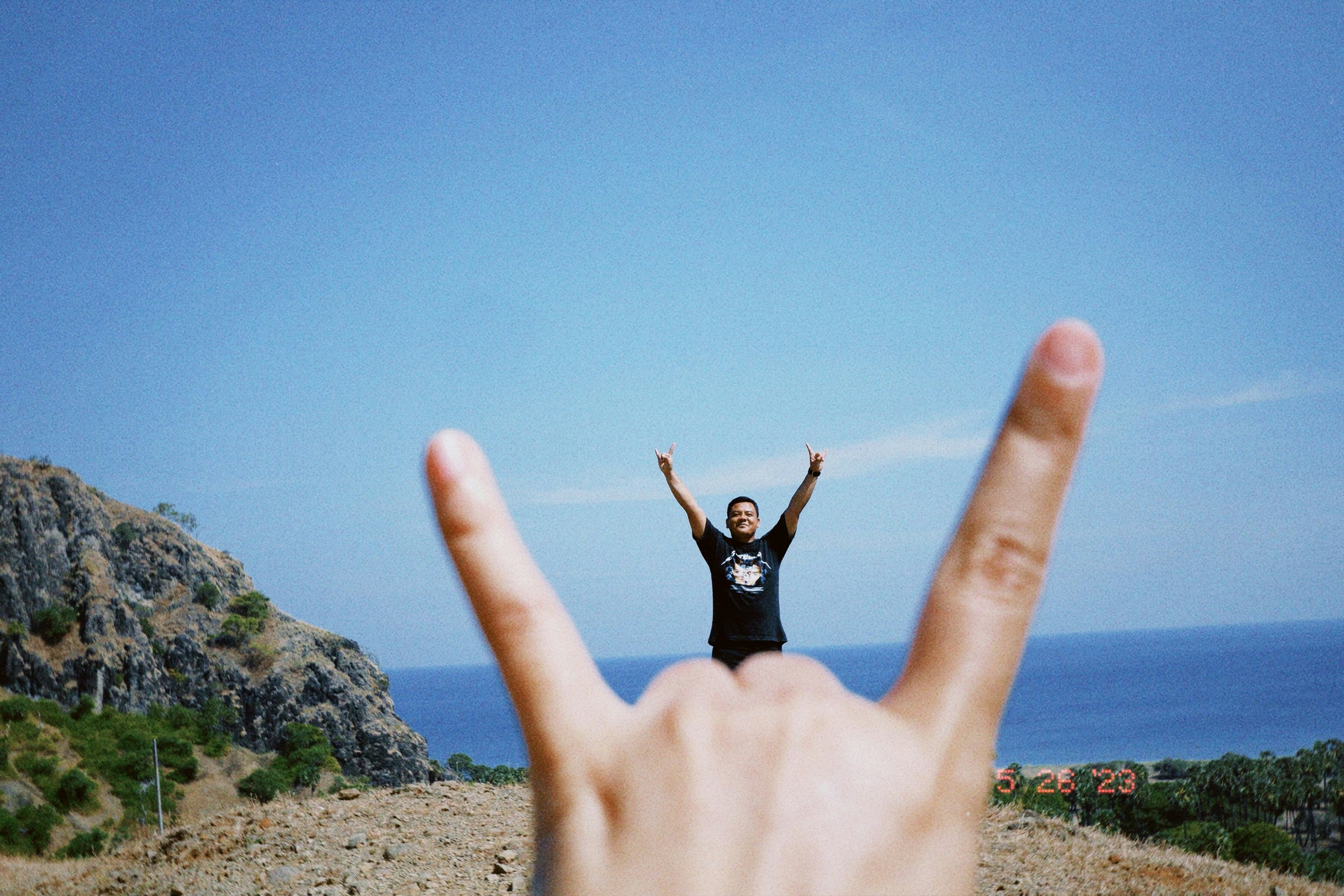 Frame Within a Frame: A Seaside Portrait Seen Through a Giant Foreground Hand