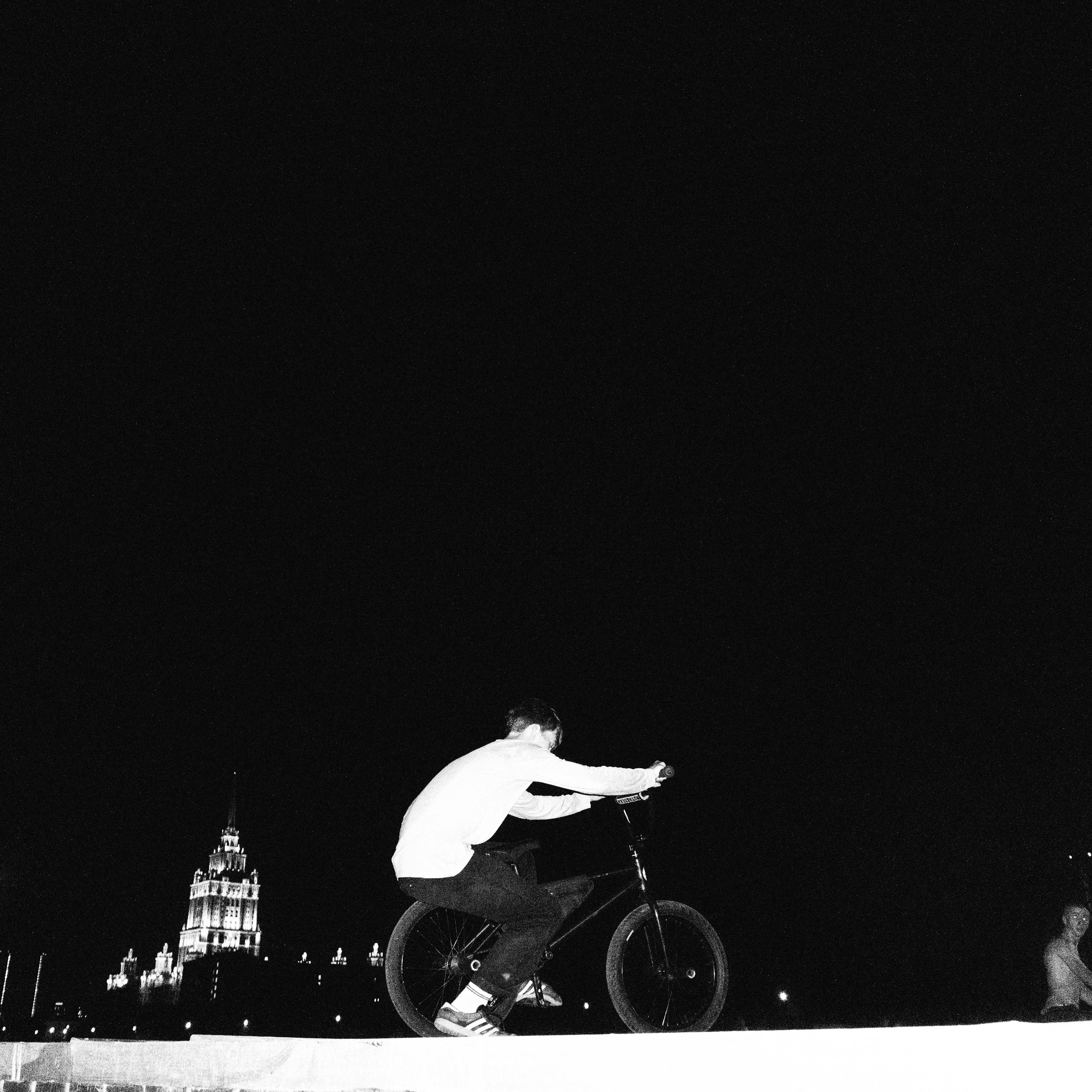 Midnight Ride: A lone cyclist on a moonlit horizon