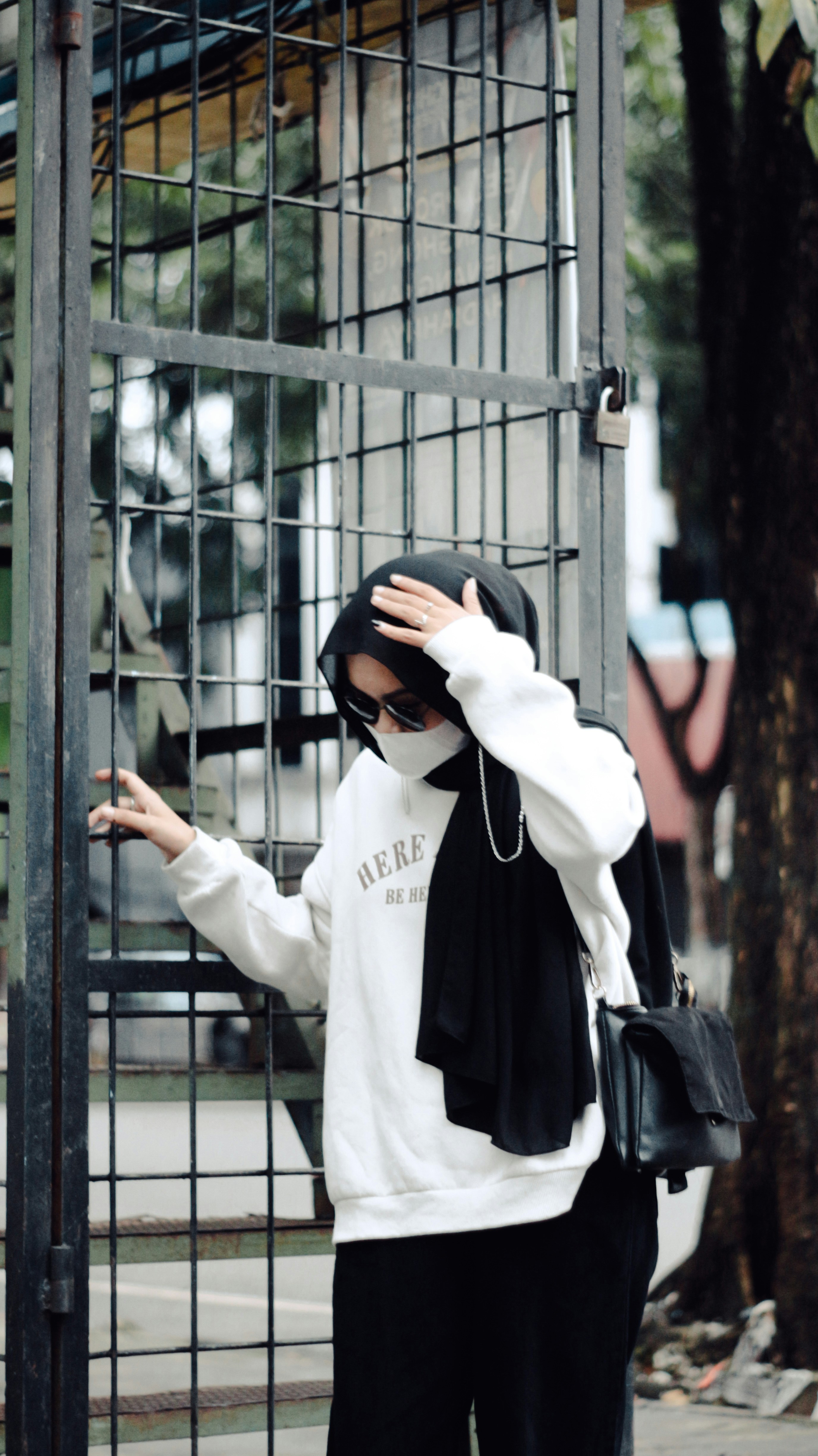 Muted Focus at the Gate: A Quiet Street Portrait