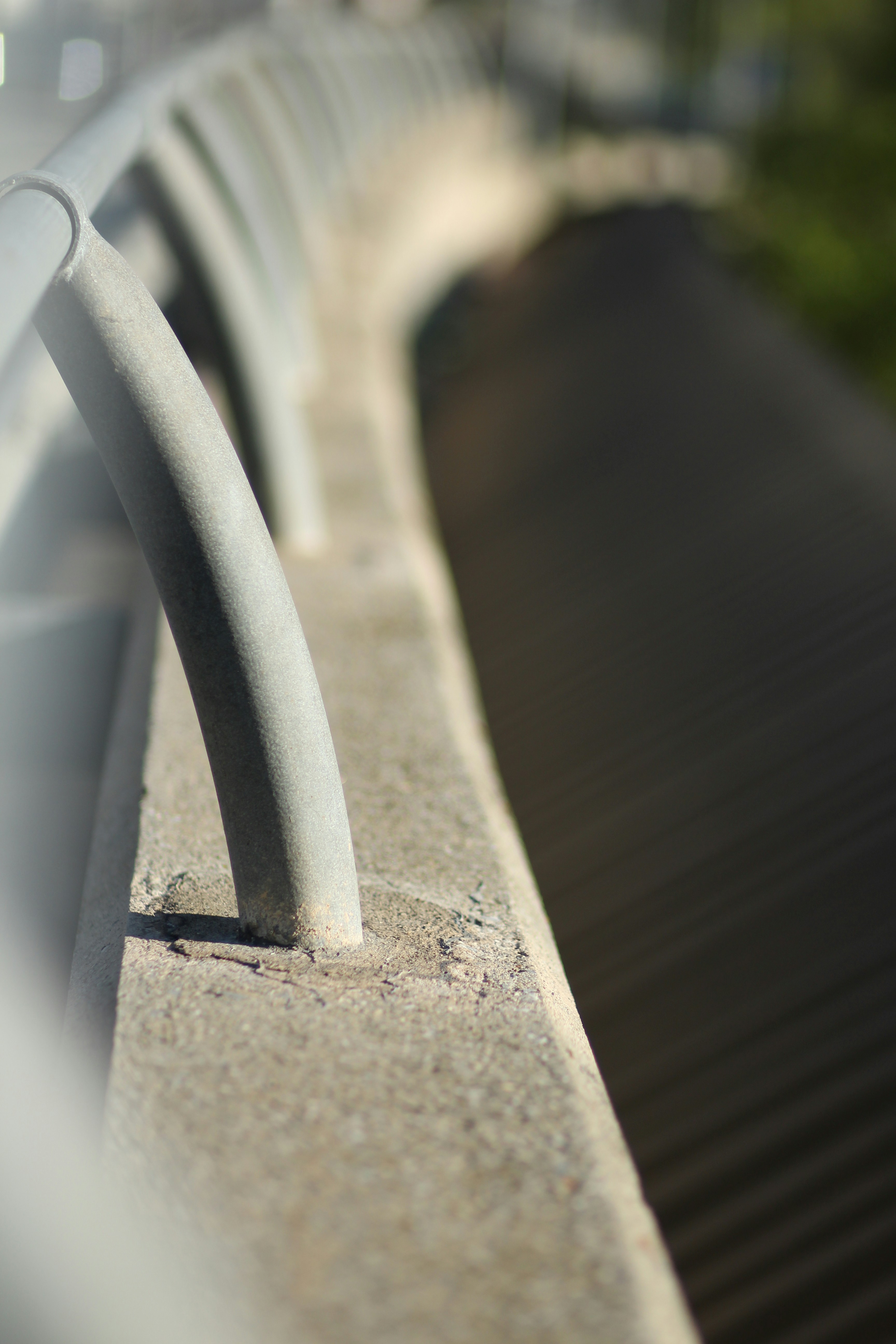 Leading Line on a Quiet Bridge: Curved Rails Receding into Blur