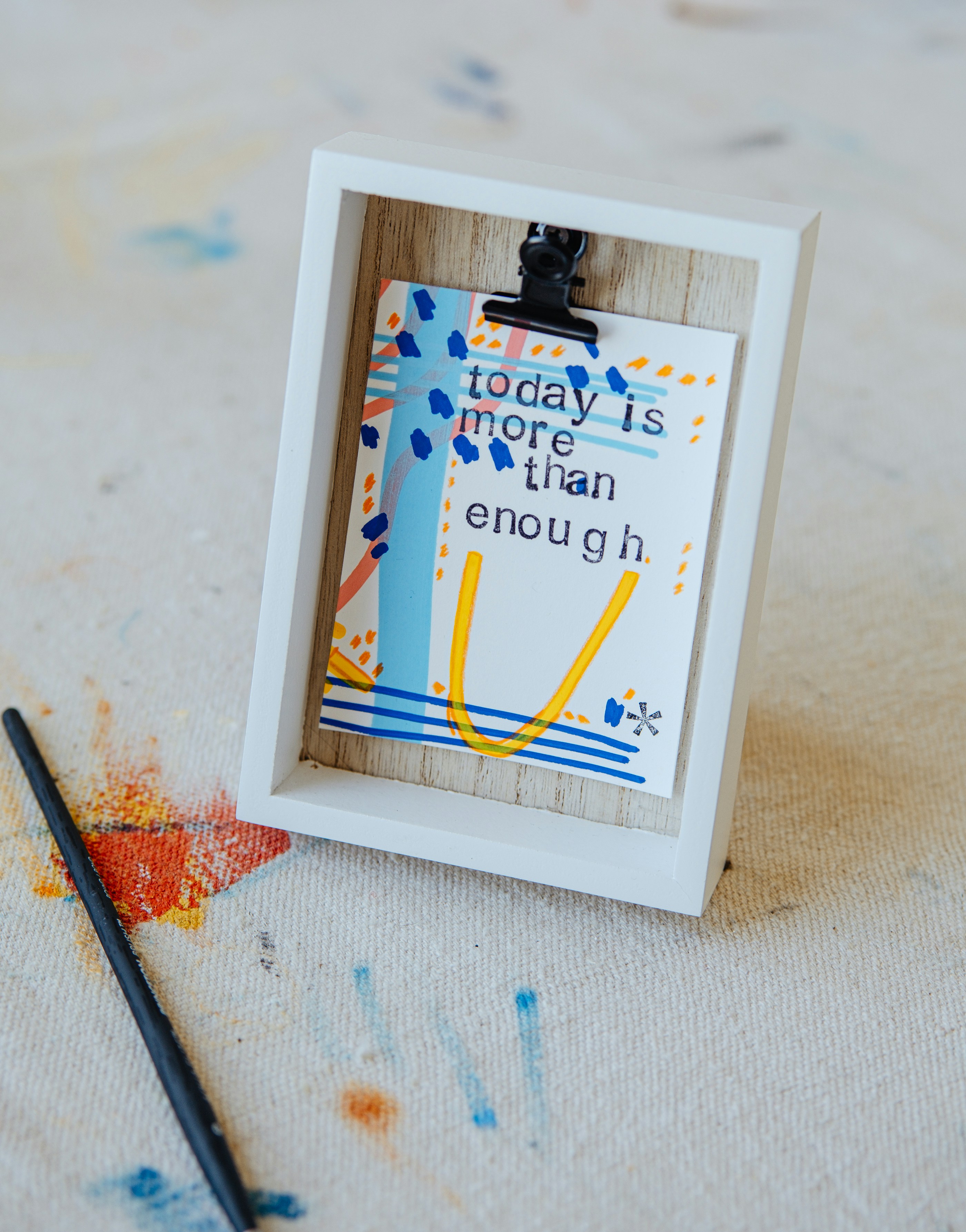 A picture frame with a quote on it next to a paintbrush photo – Free ...